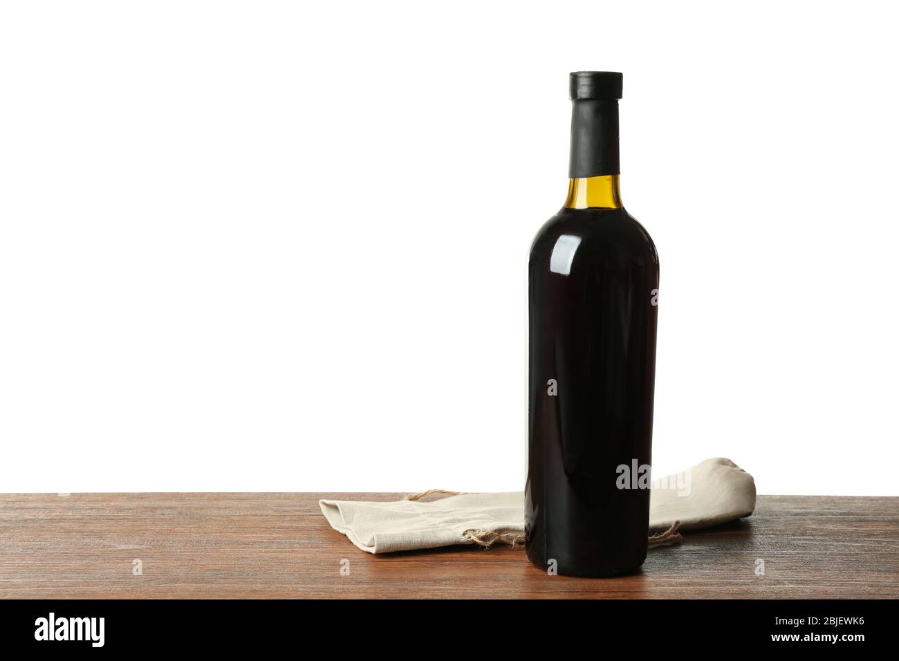 Table with wine bottle on white background Stock Photo - Alamy
