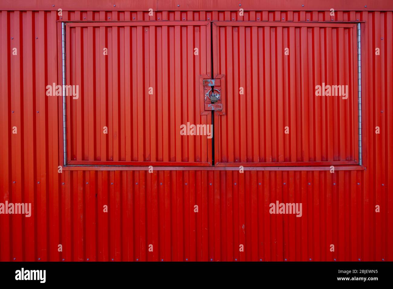 red vertical metal siding body of serving station windows locked and ...