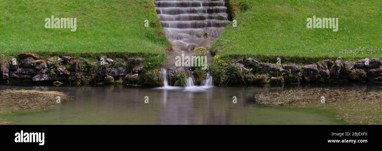 Panoramic photo of a waterfall flowing down stairs in an ornamental ...