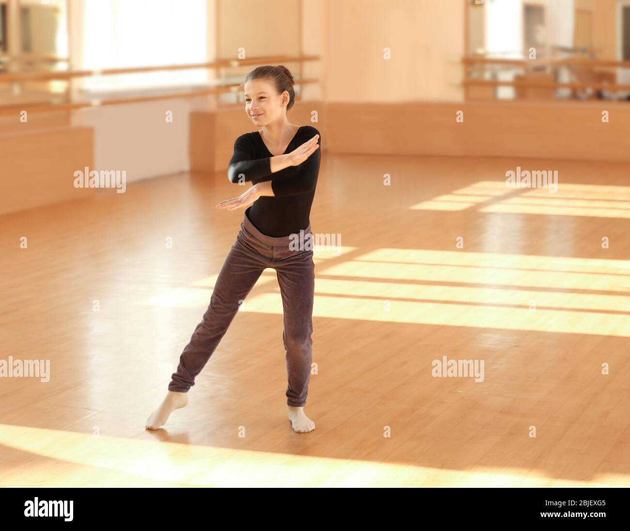 Cute little girl training in dance studio Stock Photo - Alamy