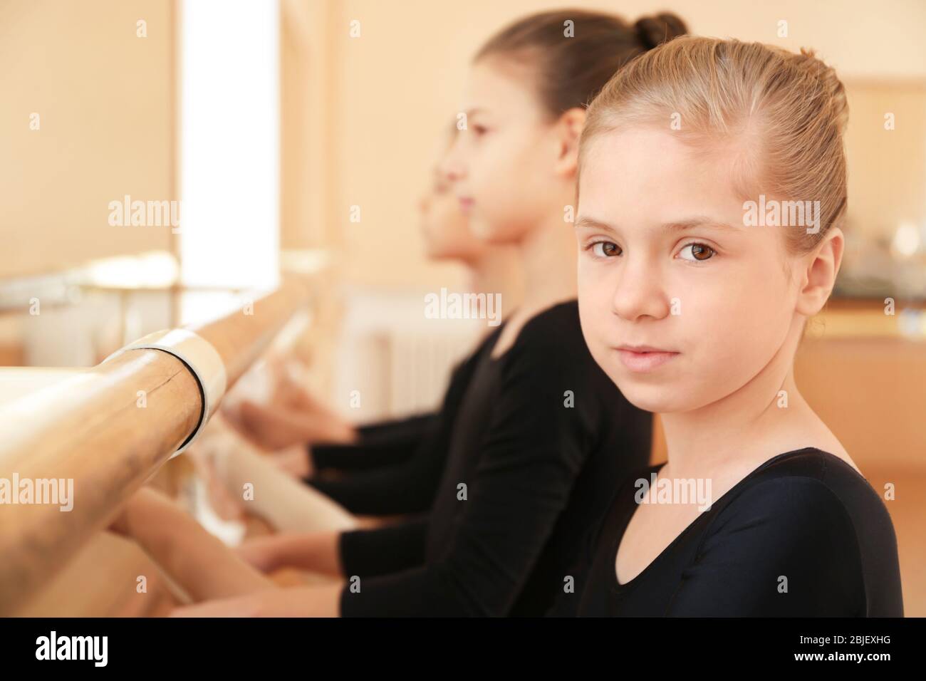 Cute little girl training in dance studio Stock Photo - Alamy