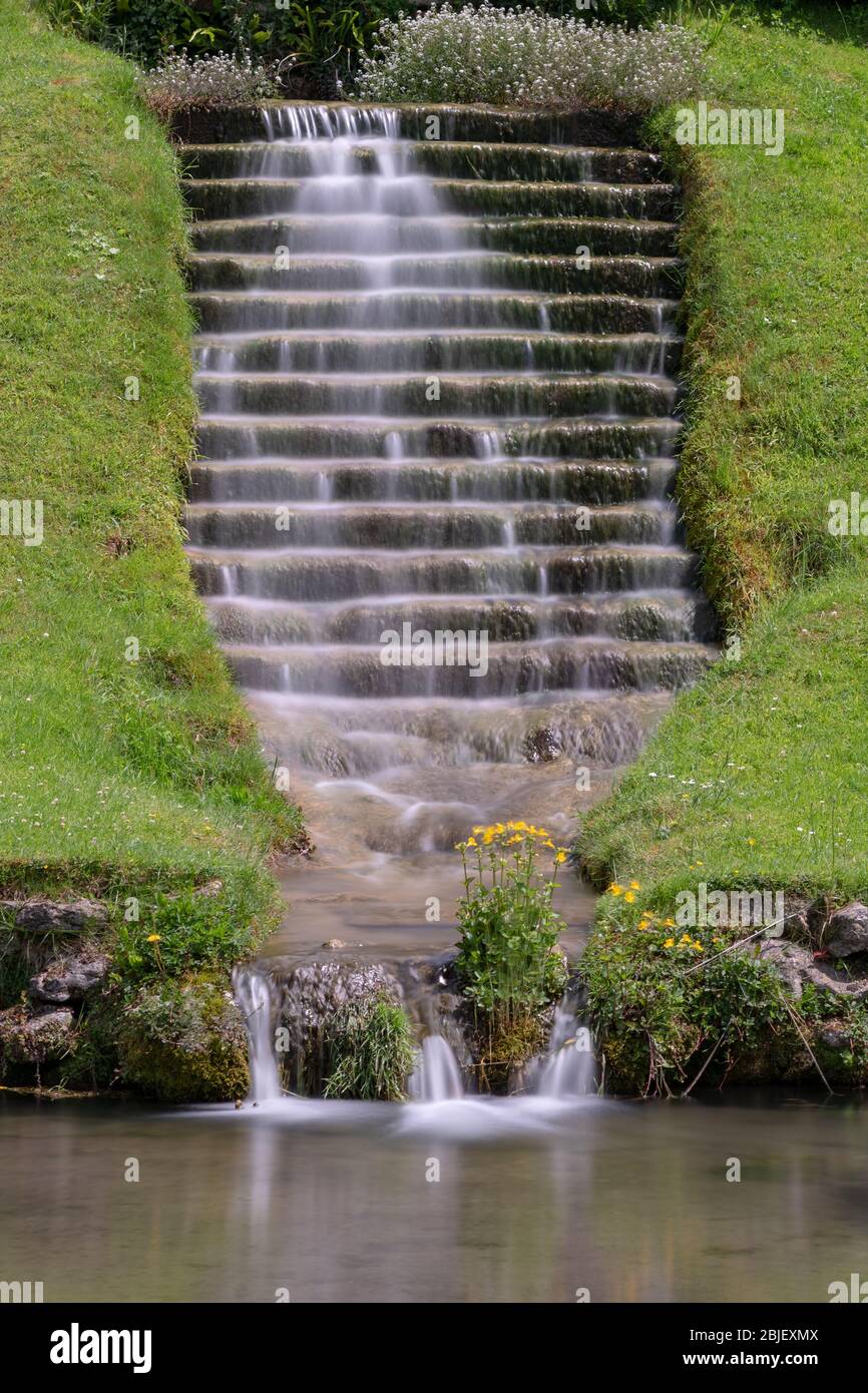 Long exposure of a waterfall flowing down stairs in an ornamental ...