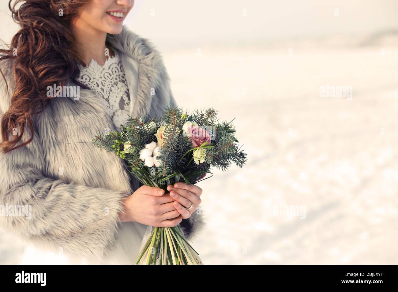 Beautiful bride with bouquet outdoors on winter day Stock Photo - Alamy