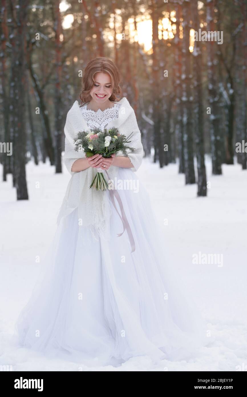 Beautiful bride with bouquet outdoors on winter day Stock Photo - Alamy