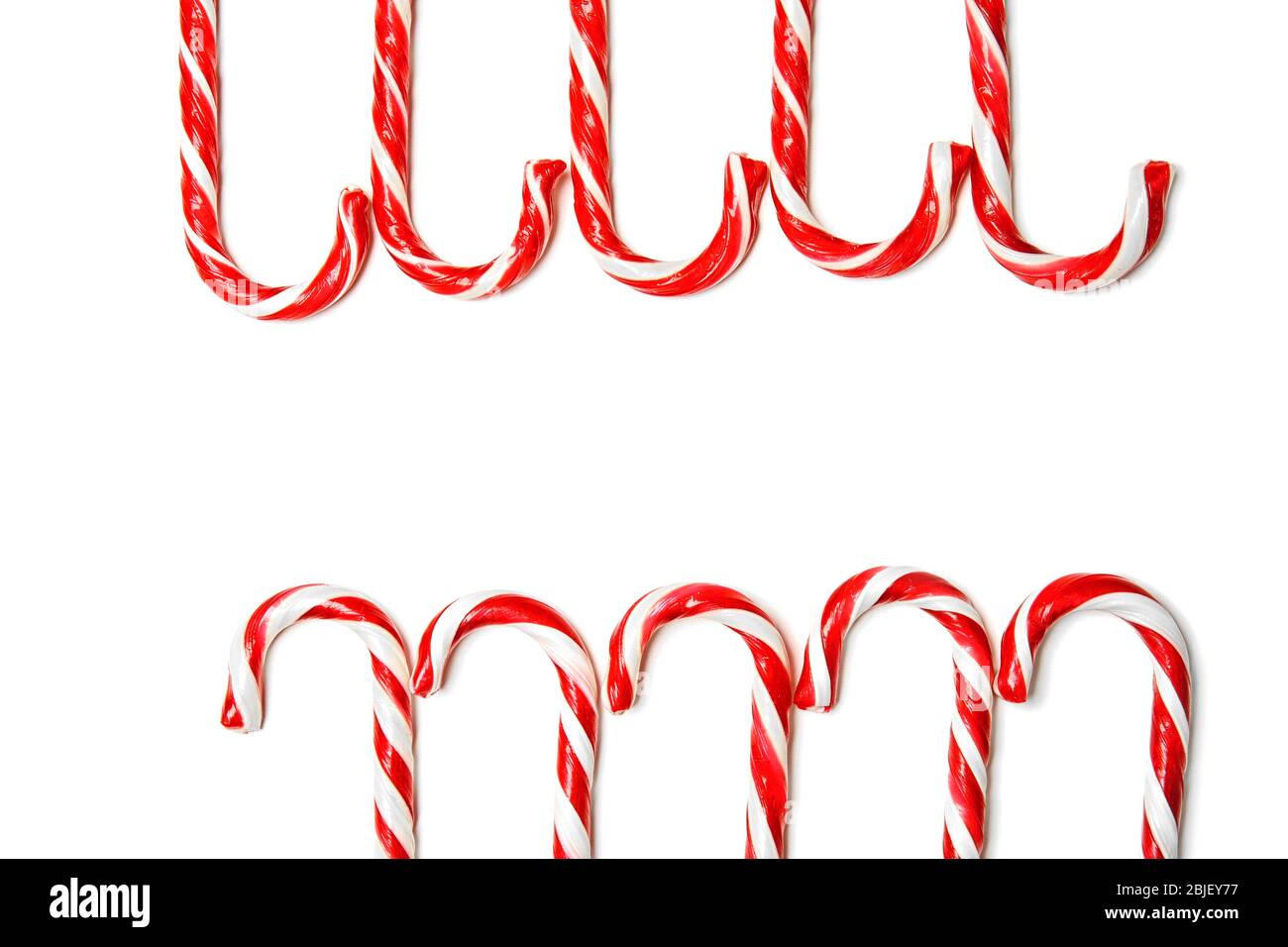 Candy canes on white background Stock Photo - Alamy