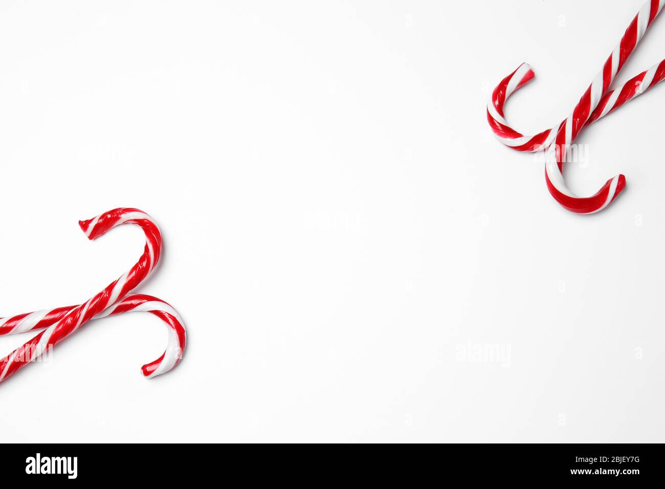 Candy canes on white background Stock Photo - Alamy