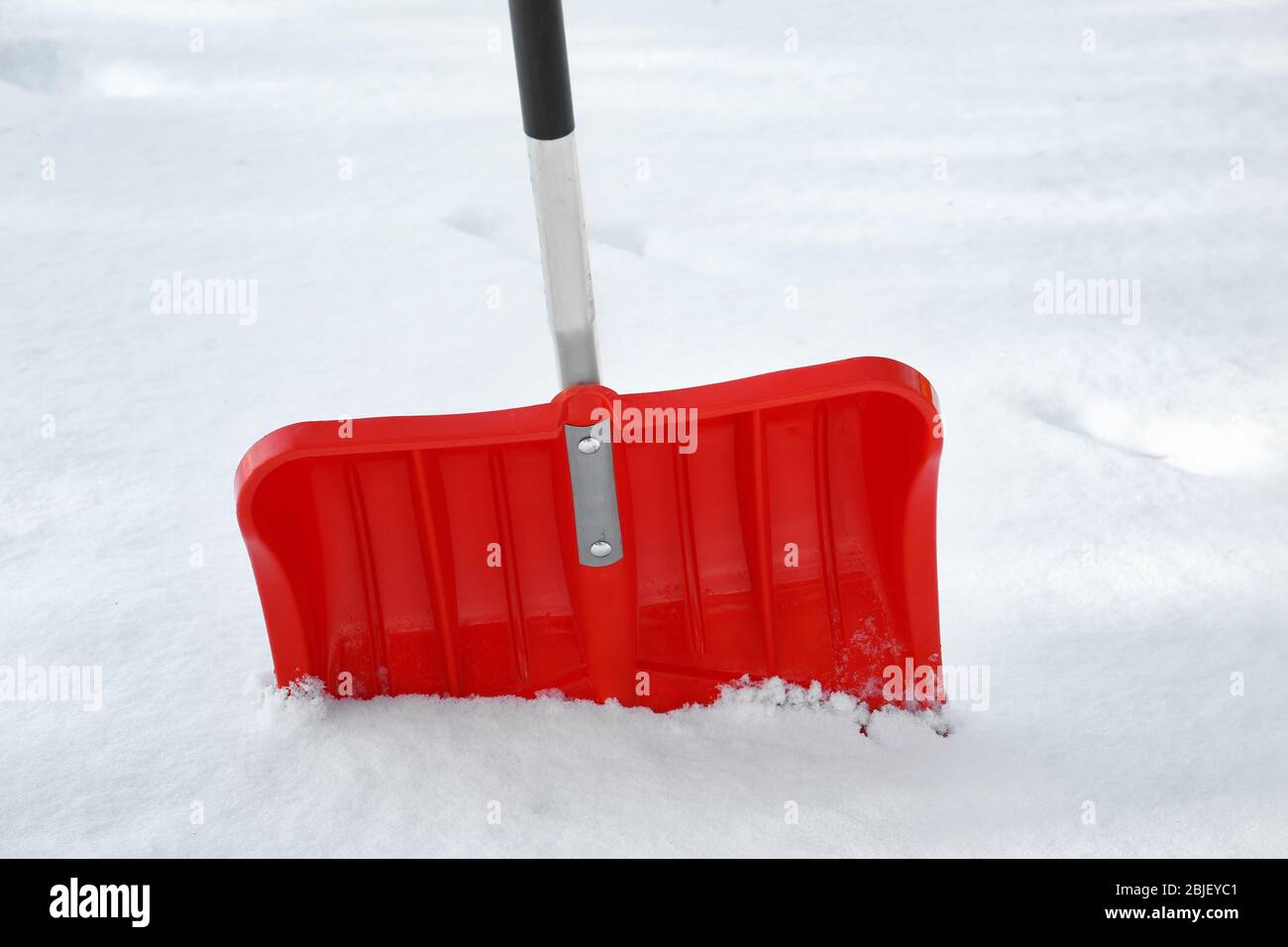 Red shovel for snow removal Stock Photo - Alamy
