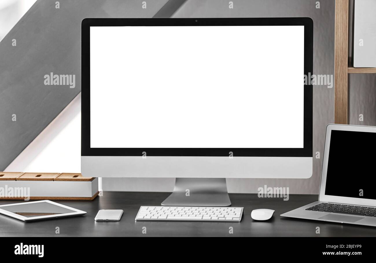 Modern design of workplace with big computer monitor Stock Photo - Alamy