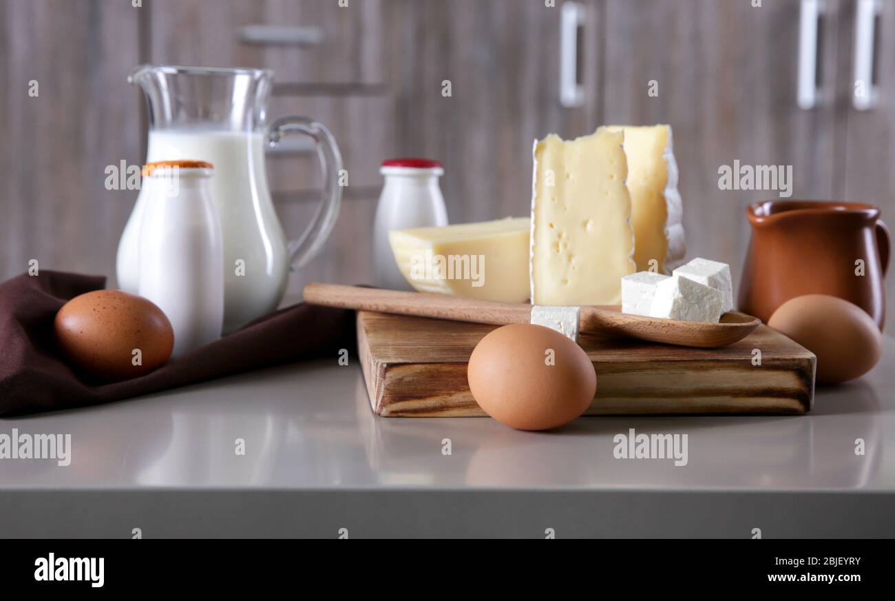 Different dairy products on kitchen table Stock Photo - Alamy