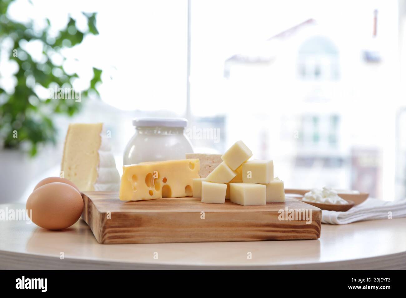 Different dairy products on kitchen table Stock Photo - Alamy