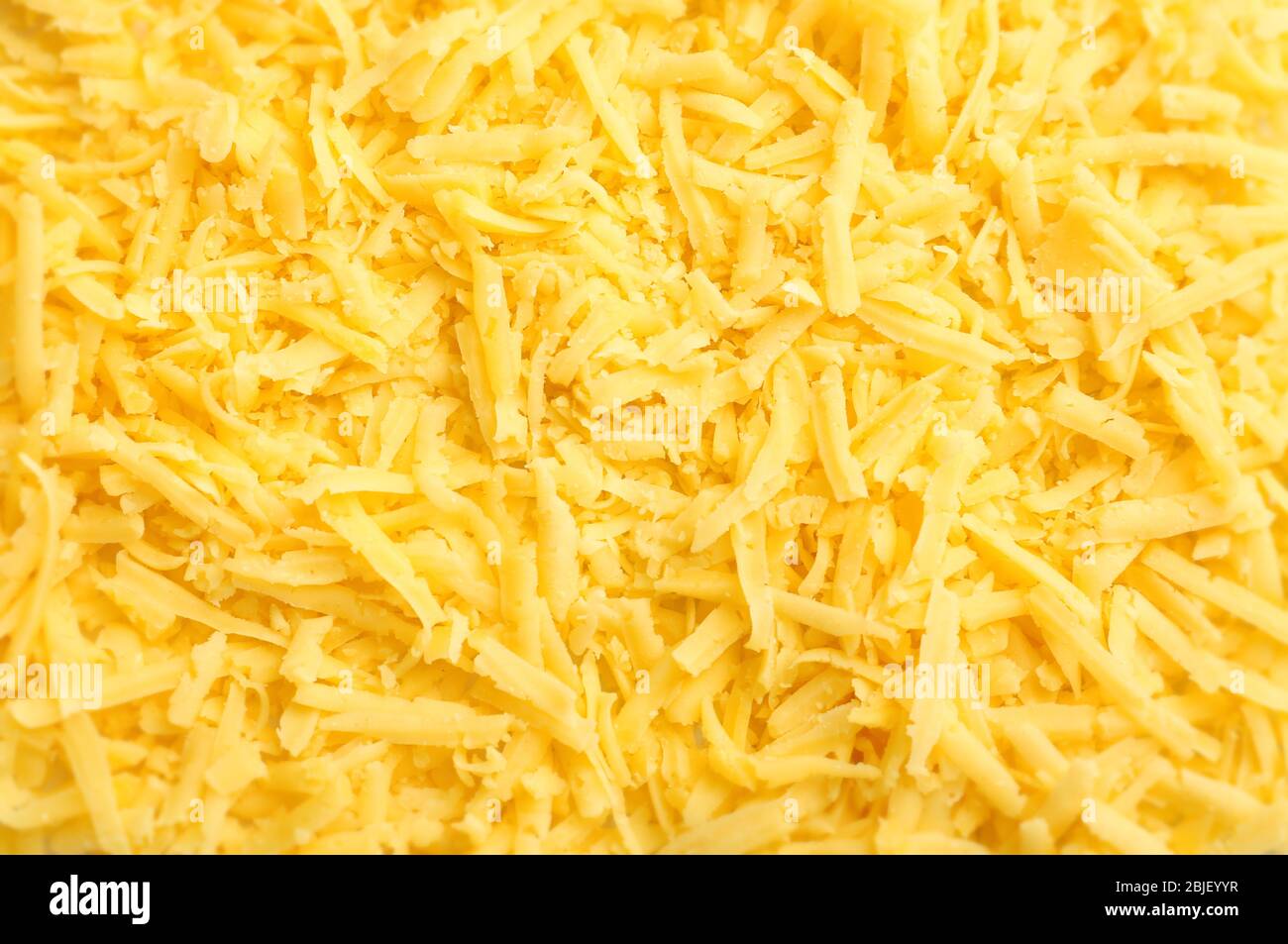 Grated cheese background Stock Photo - Alamy