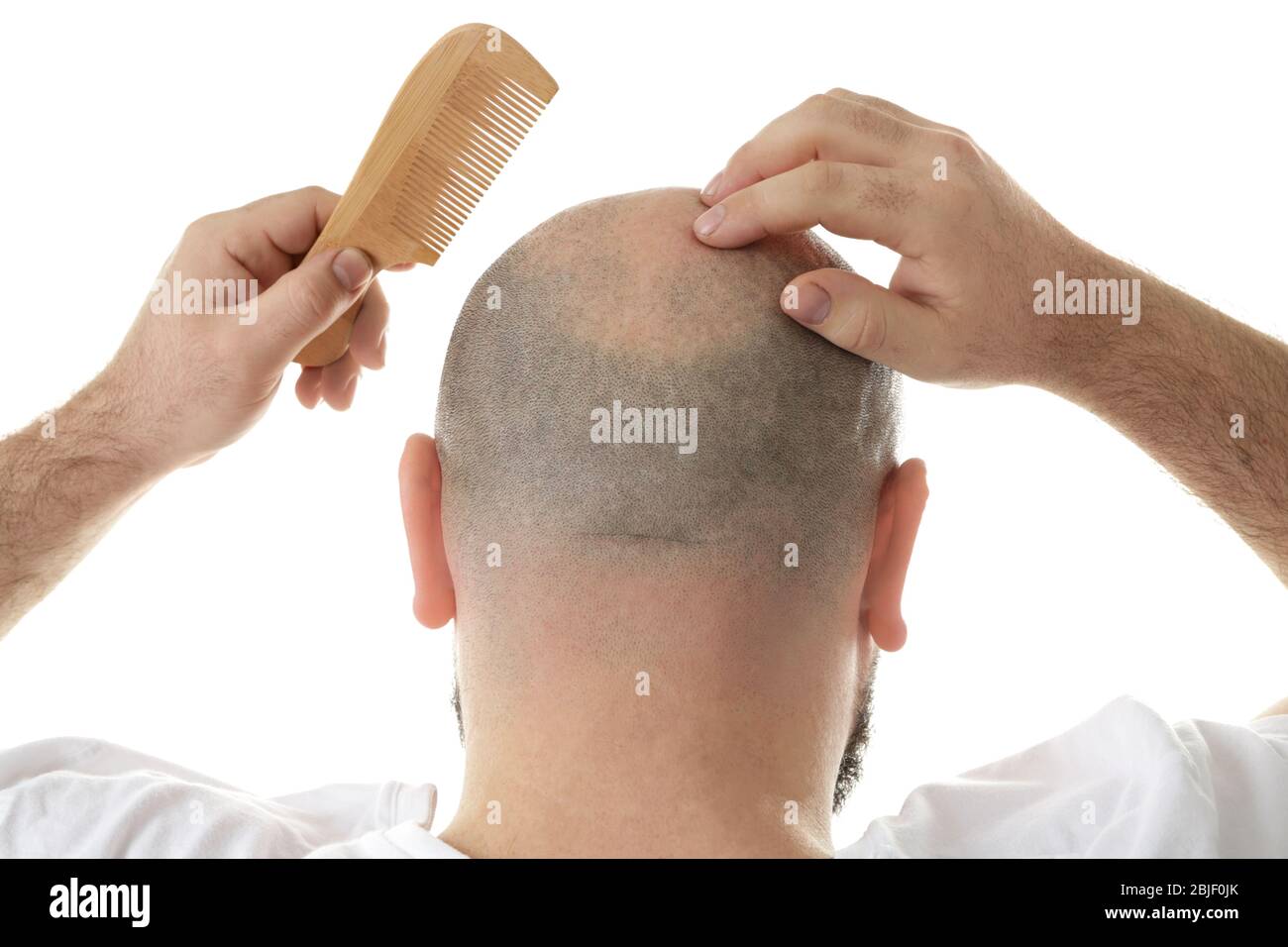 Bald adult man with comb on white background Stock Photo - Alamy