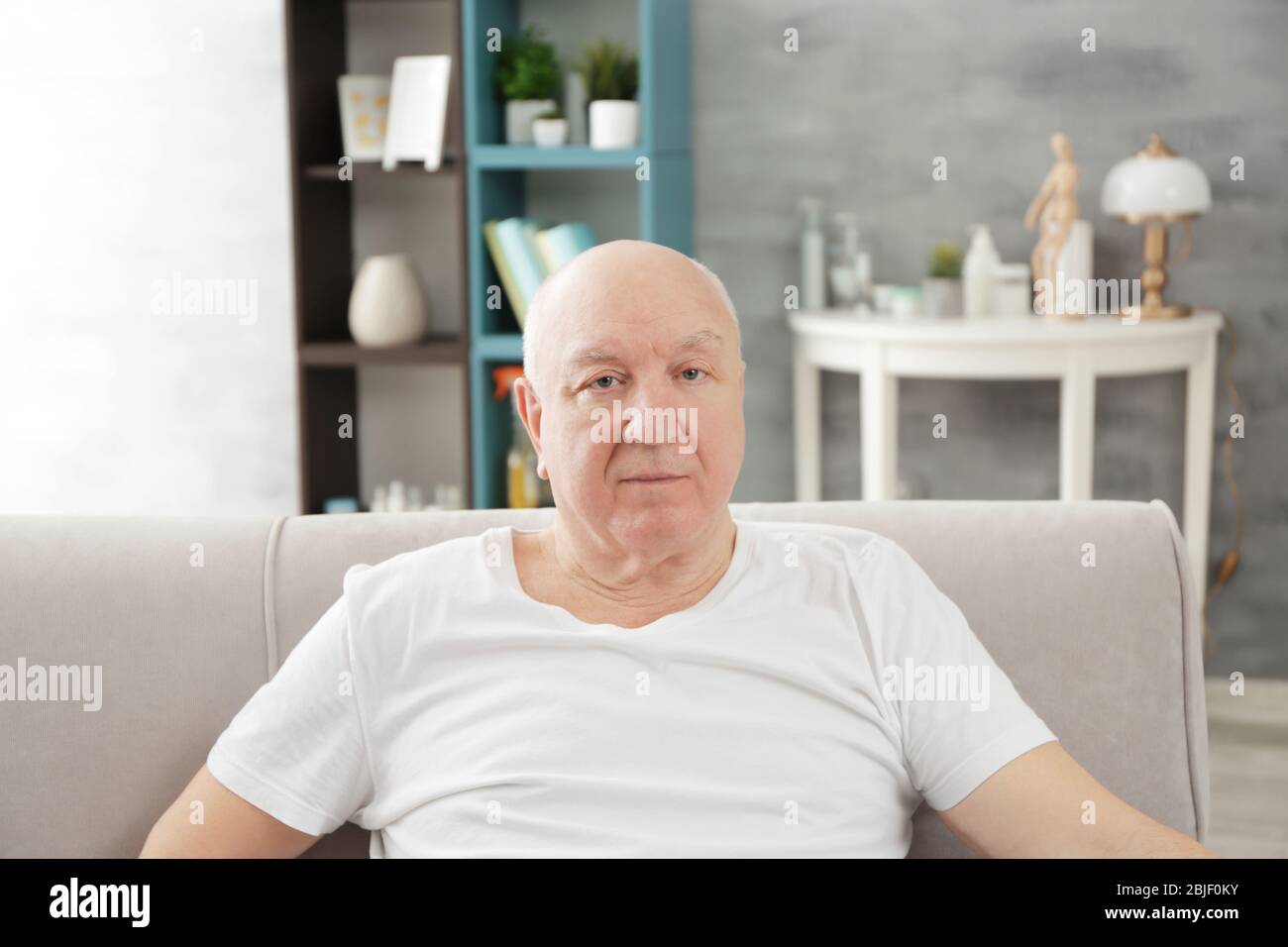 Senior bald man at home Stock Photo - Alamy