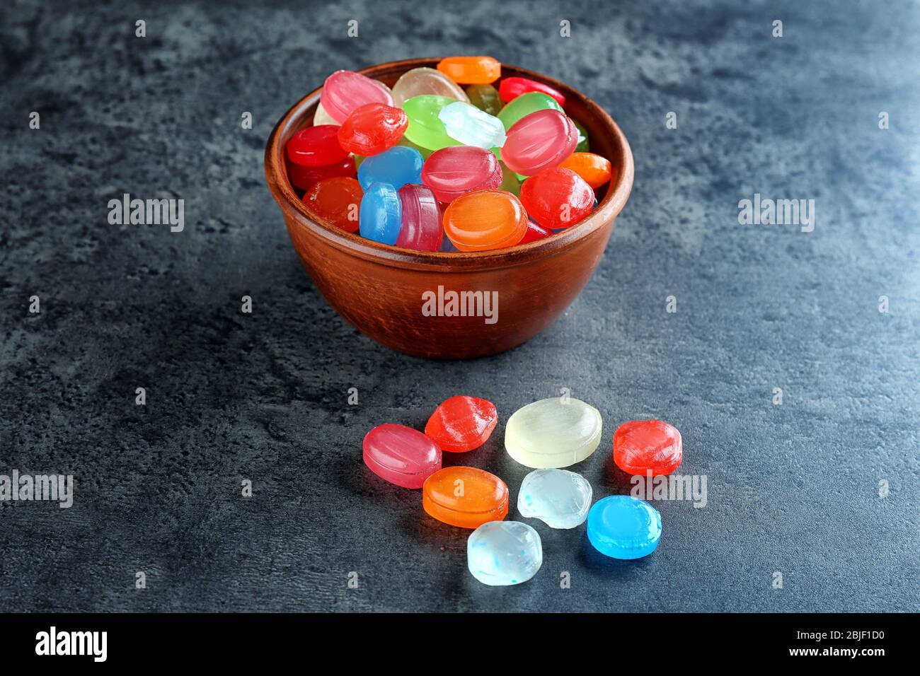 Different cough drops on color background Stock Photo - Alamy