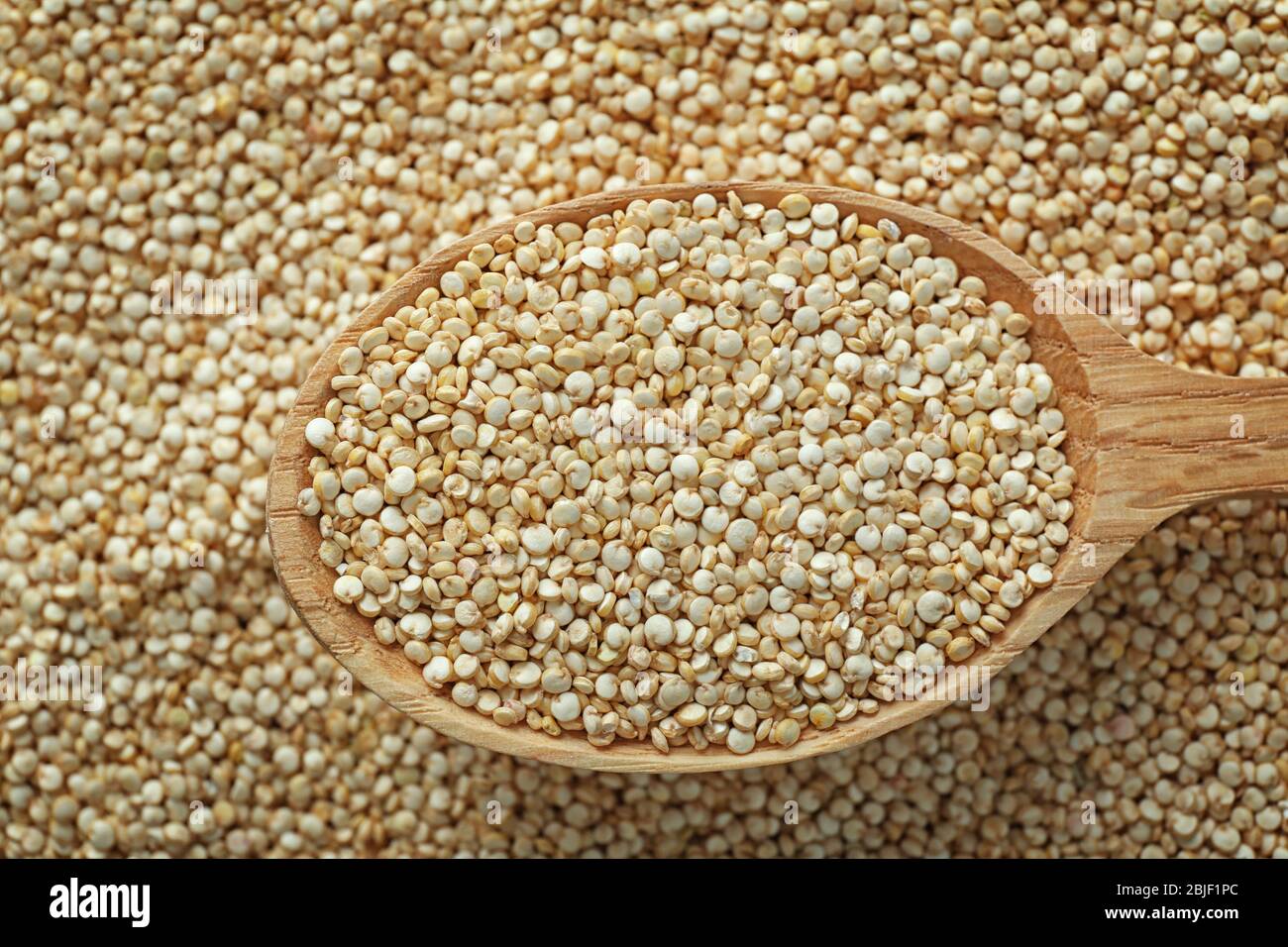 Organic quinoa seeds with spoon, closeup Stock Photo - Alamy
