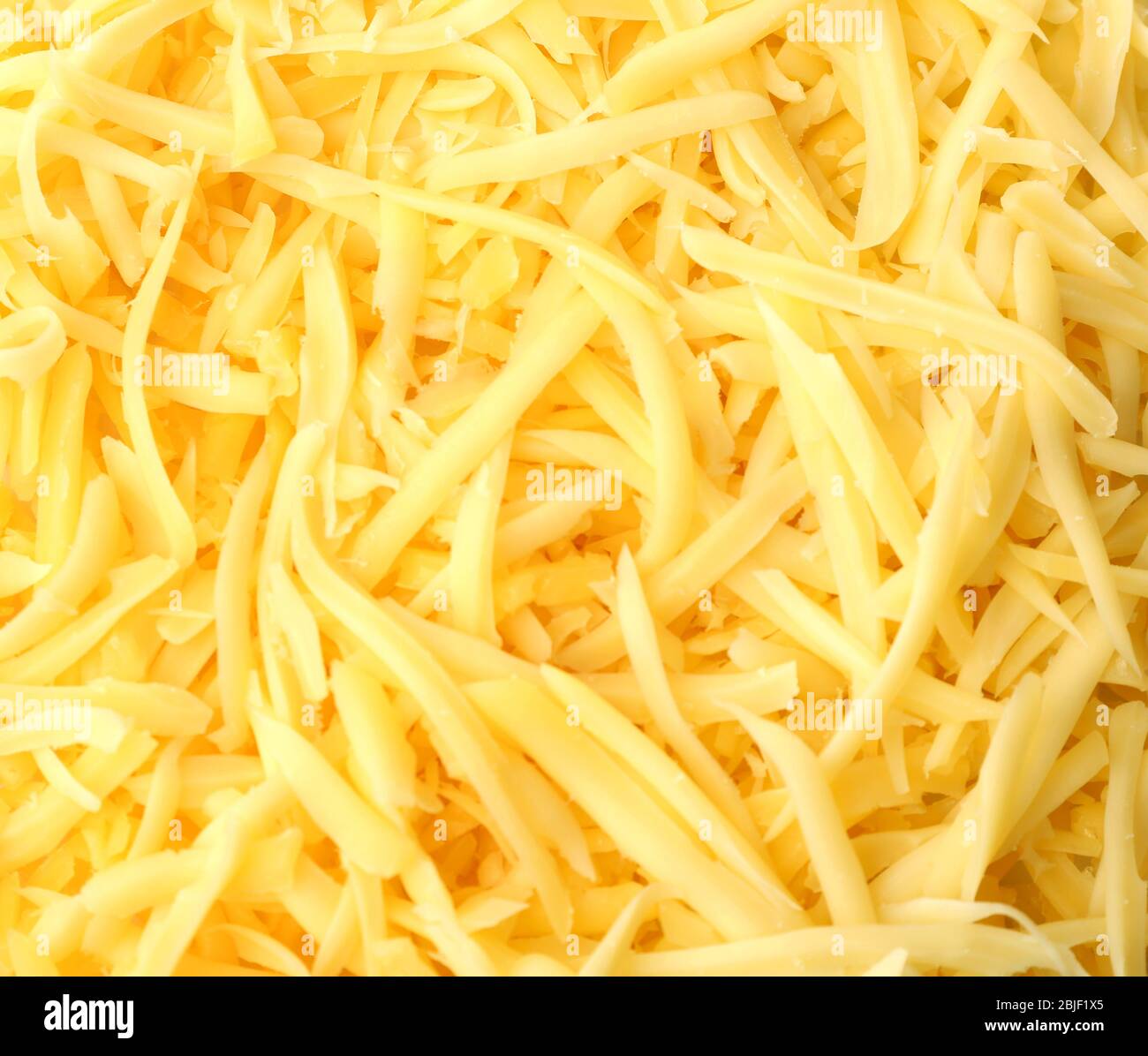 Grated cheese background Stock Photo - Alamy