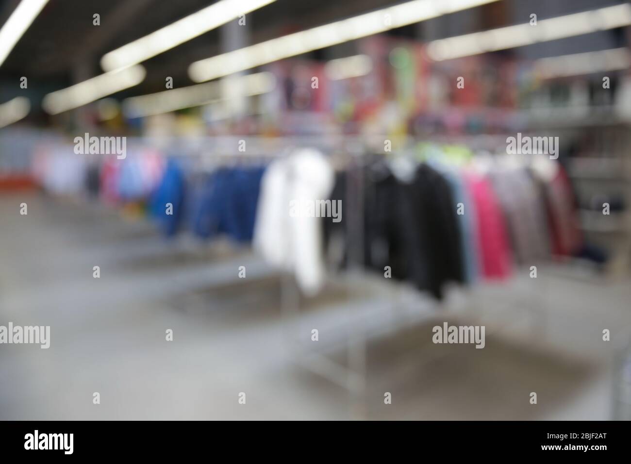 Blurred view of clothes in supermarket Stock Photo - Alamy
