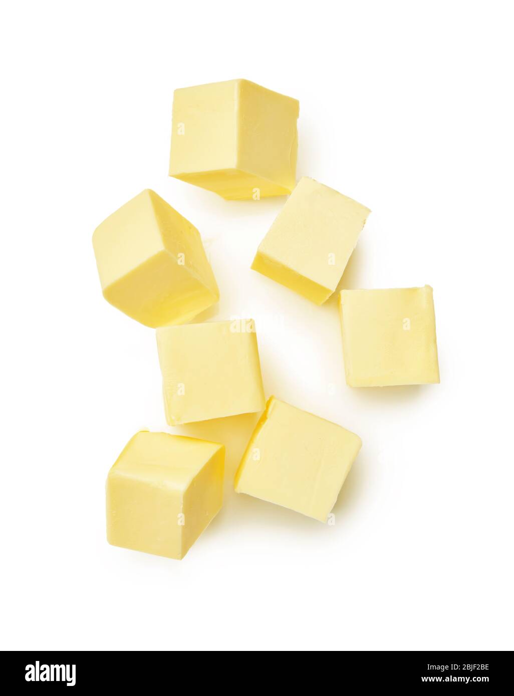 Pieces of butter isolated on white background. Top view of butter cubes ...