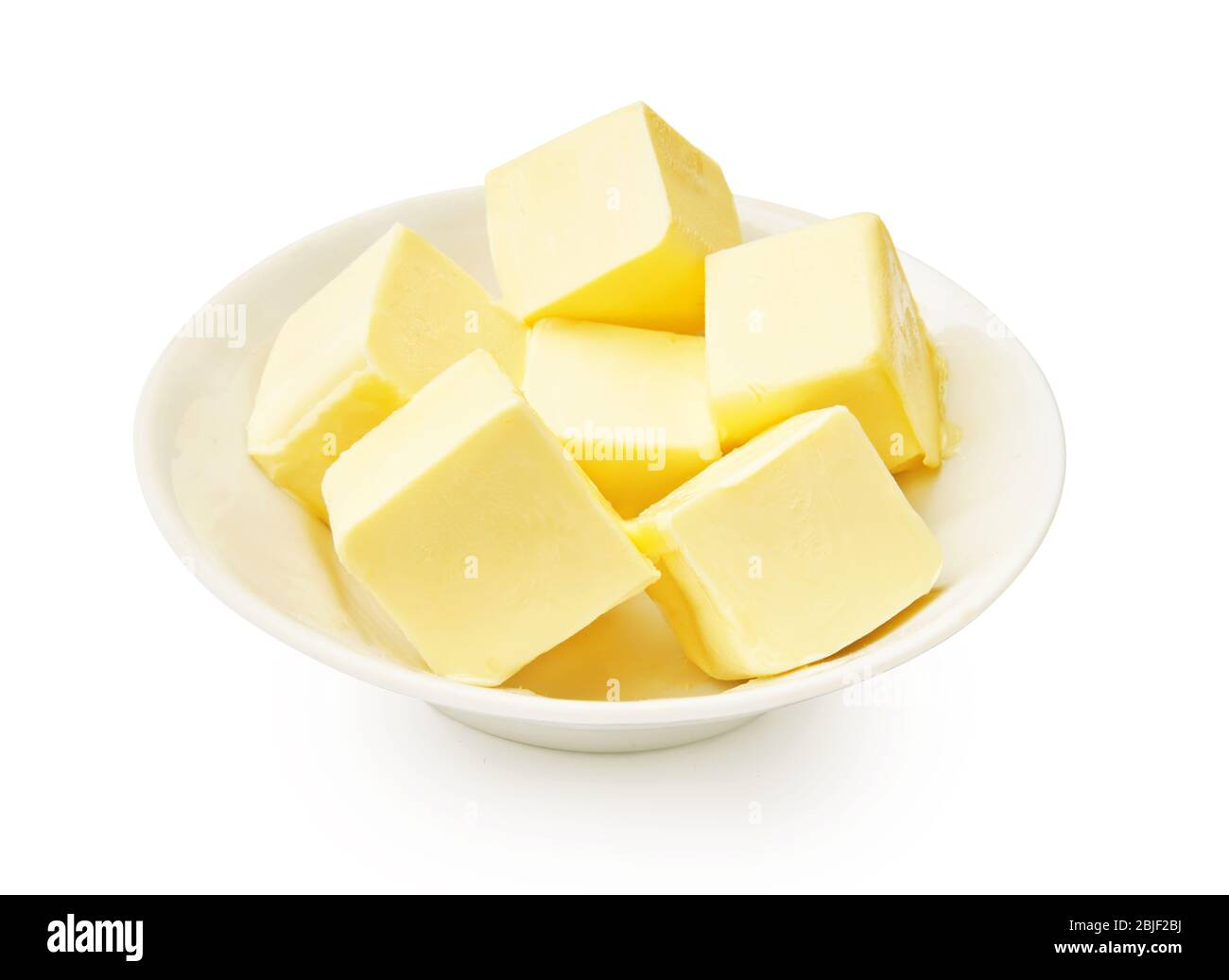 Butter pieces in white bowl isolated. Butter cubes Stock Photo - Alamy