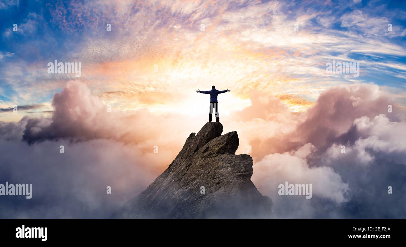Fantasy Adventure Composite with a Man on top of a Mountain Cliff with ...