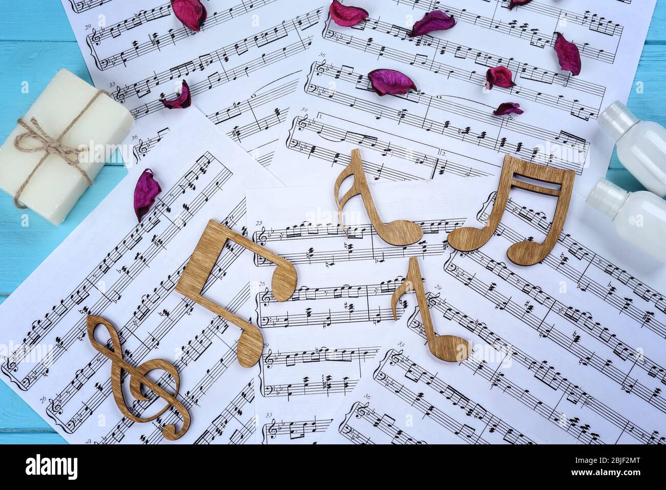 Composition of music sheets and spa supplies on wooden background Stock ...