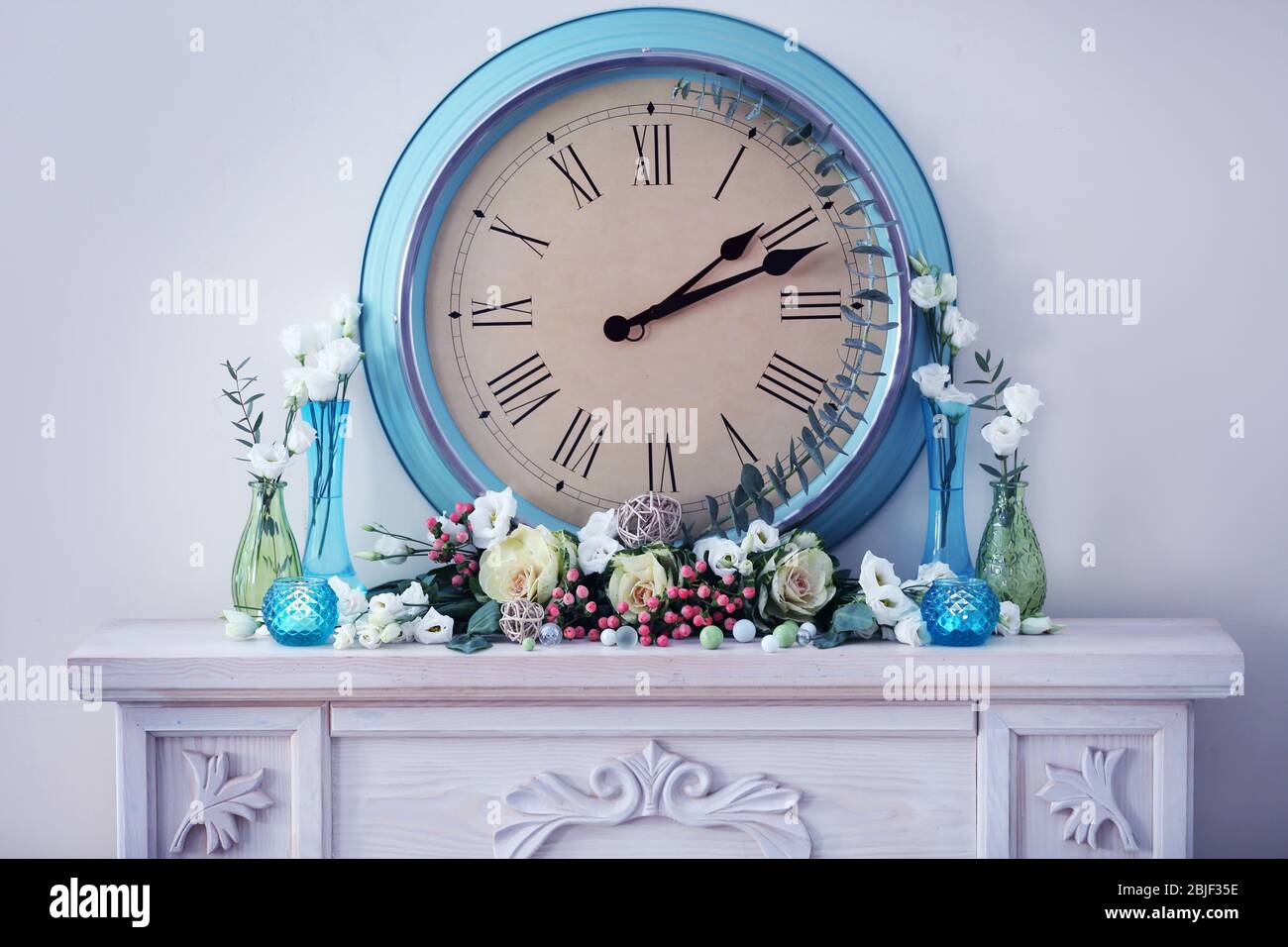 Beautiful composition with fresh flowers and vintage clock on ...