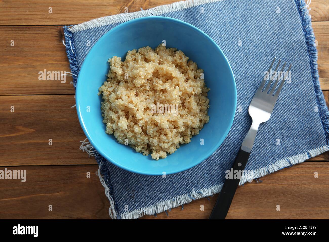 Top view of blue plate with boiled sprouted organic quinoa grains on ...