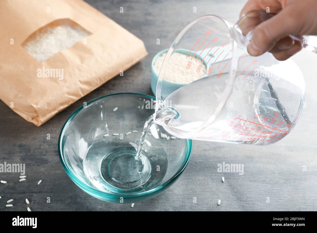 Cooking concept. Pouring water into glass bowl Stock Photo - Alamy