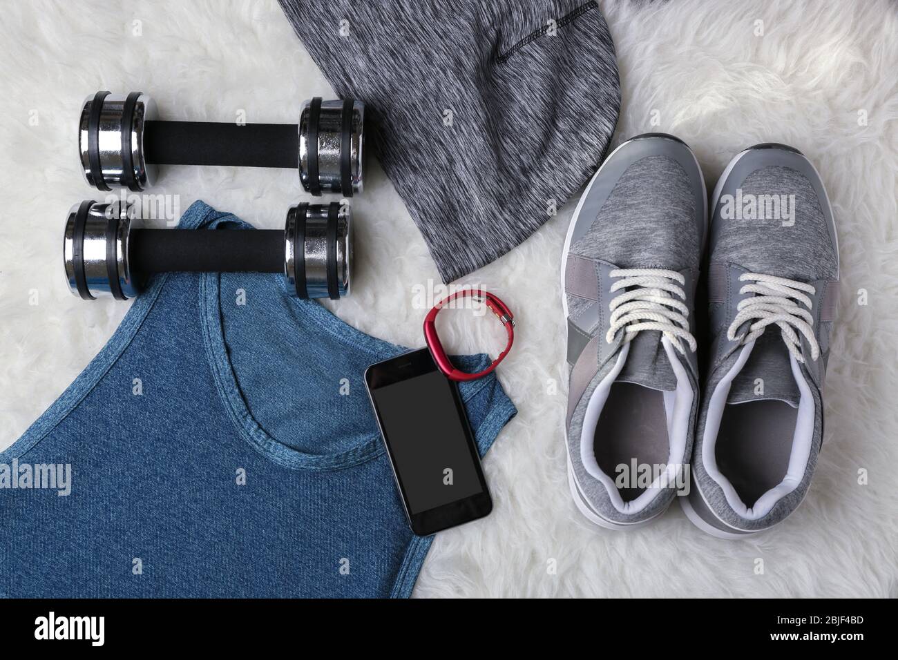 Sport stuff with fitness tracker and smartphone on fur background Stock ...