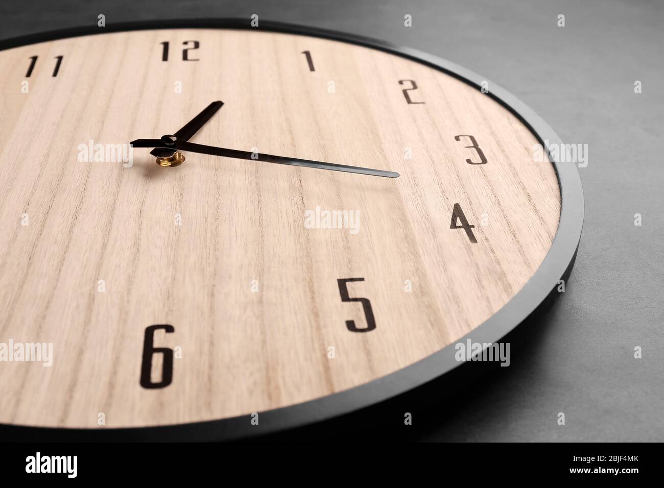 Big clock hanging on dark wall Stock Photo - Alamy