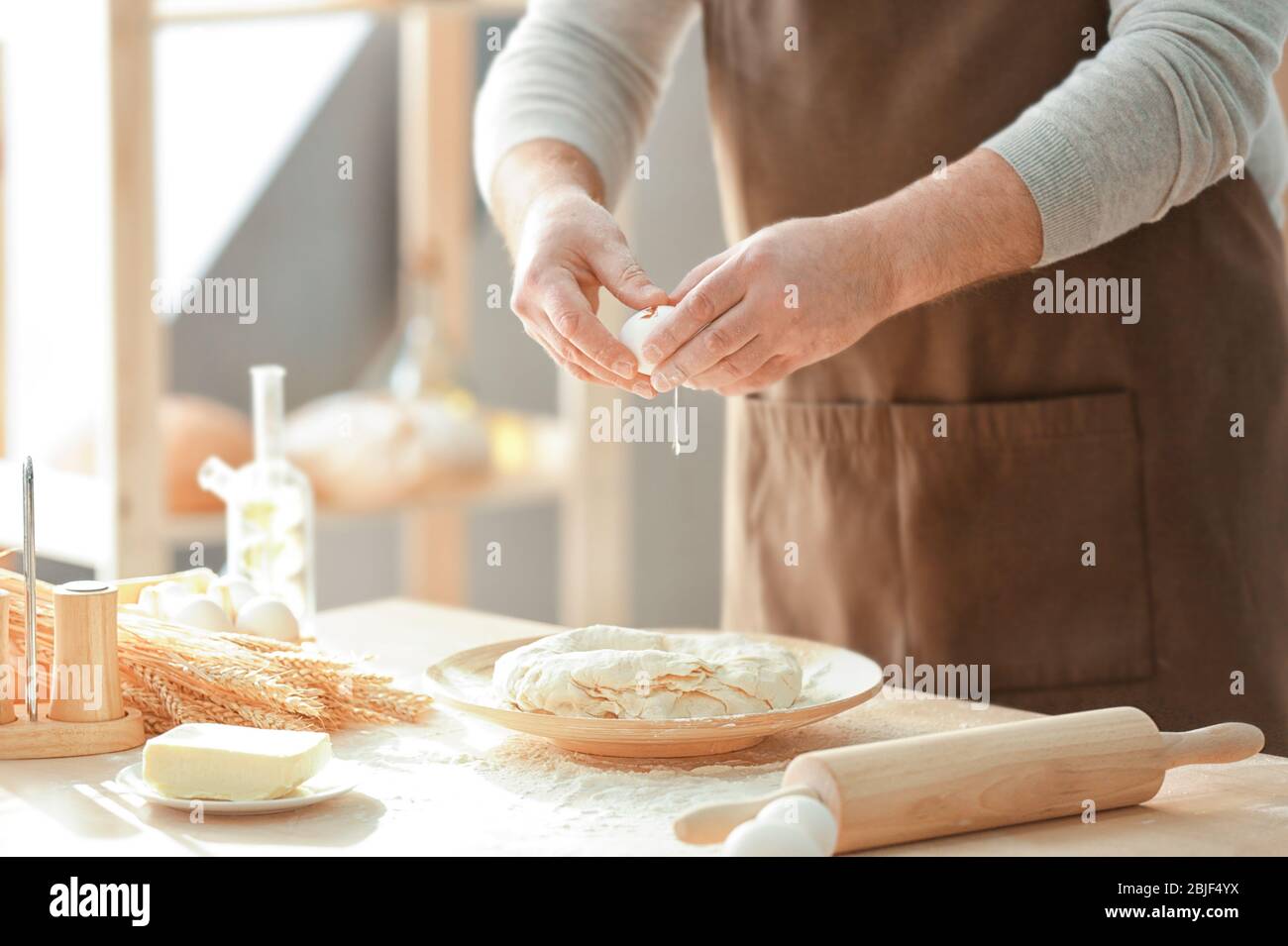 Man making dough in kitchen Stock Photo - Alamy