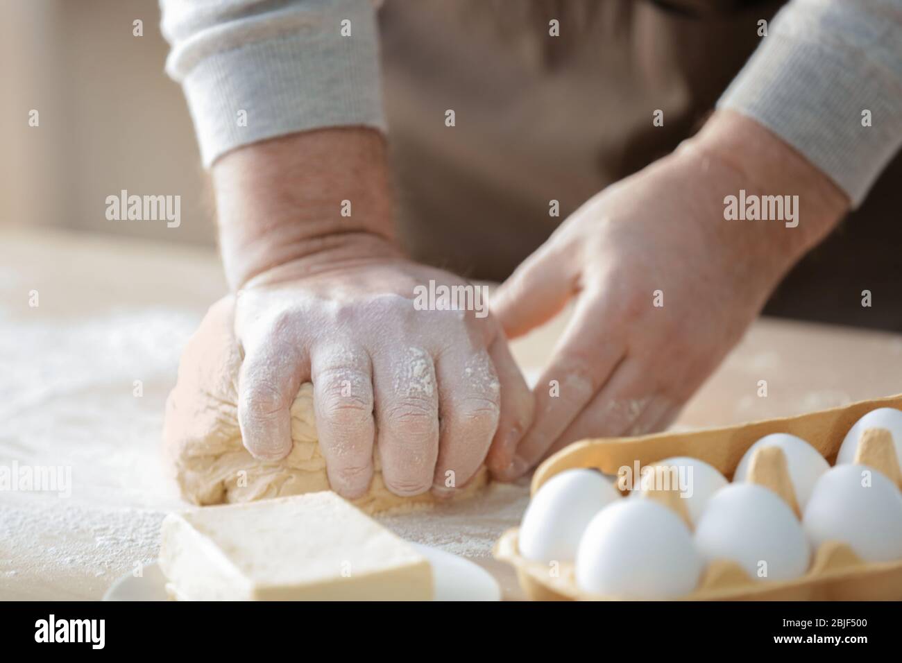 Hands of man making dough in kitchen Stock Photo - Alamy