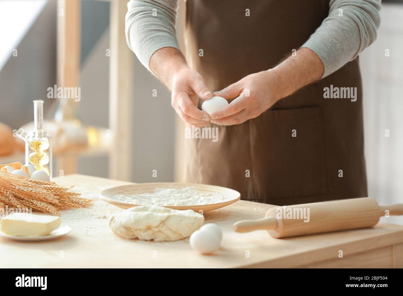 Man making dough in kitchen Stock Photo - Alamy