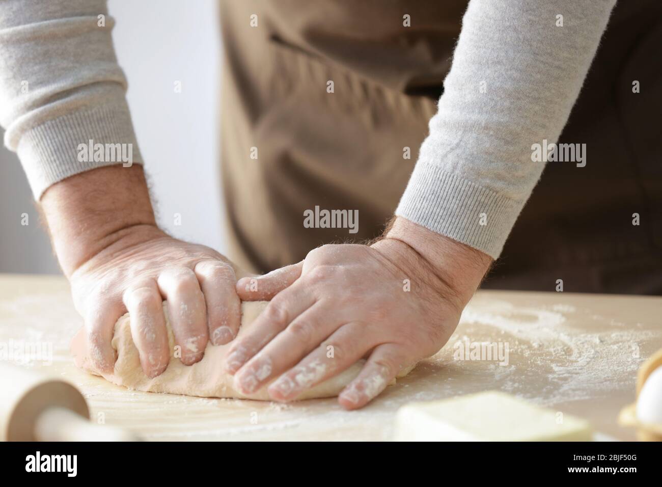 Hands of man making dough in kitchen Stock Photo - Alamy