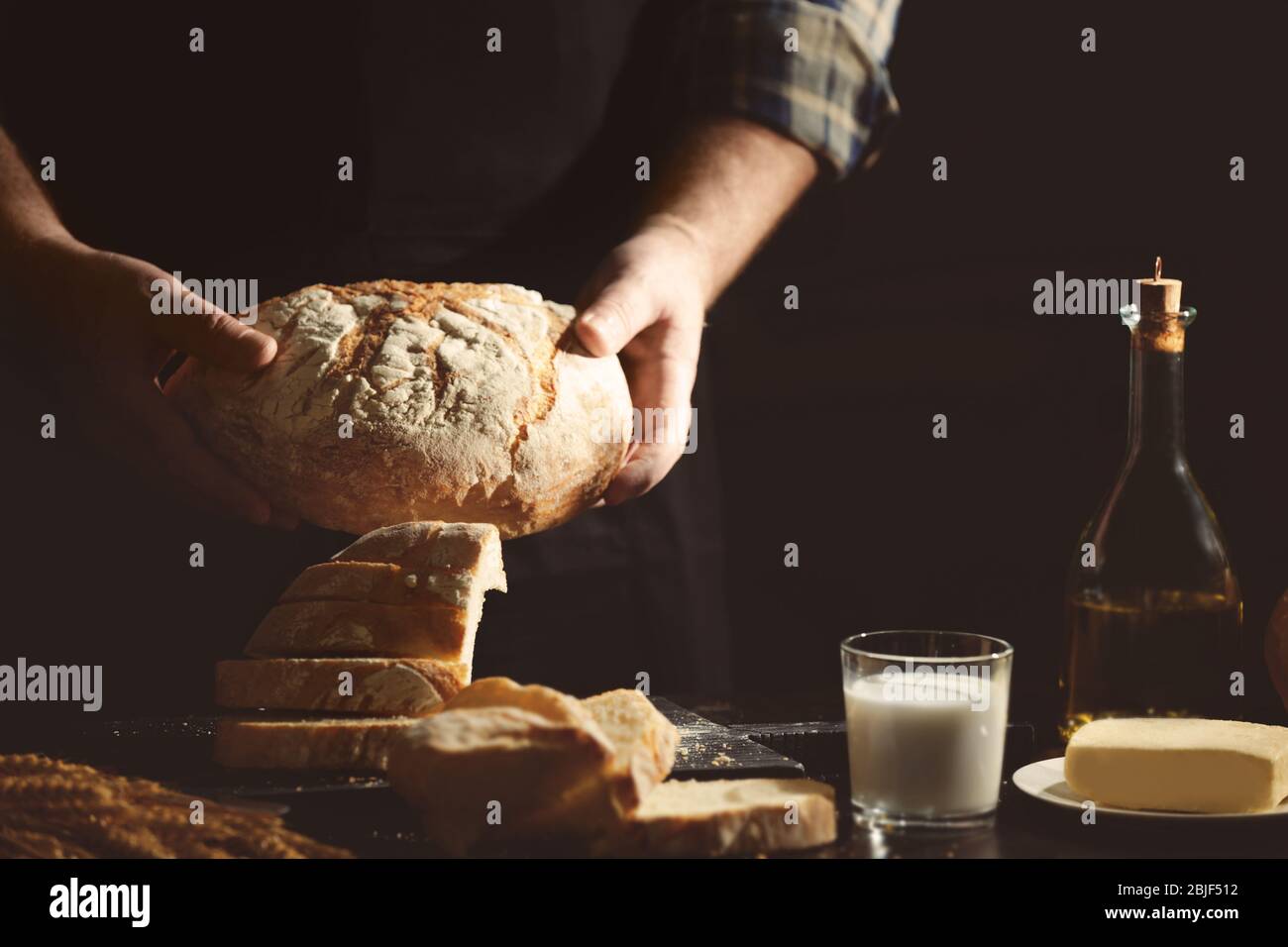 Man with loaf of bread in kitchen Stock Photo - Alamy