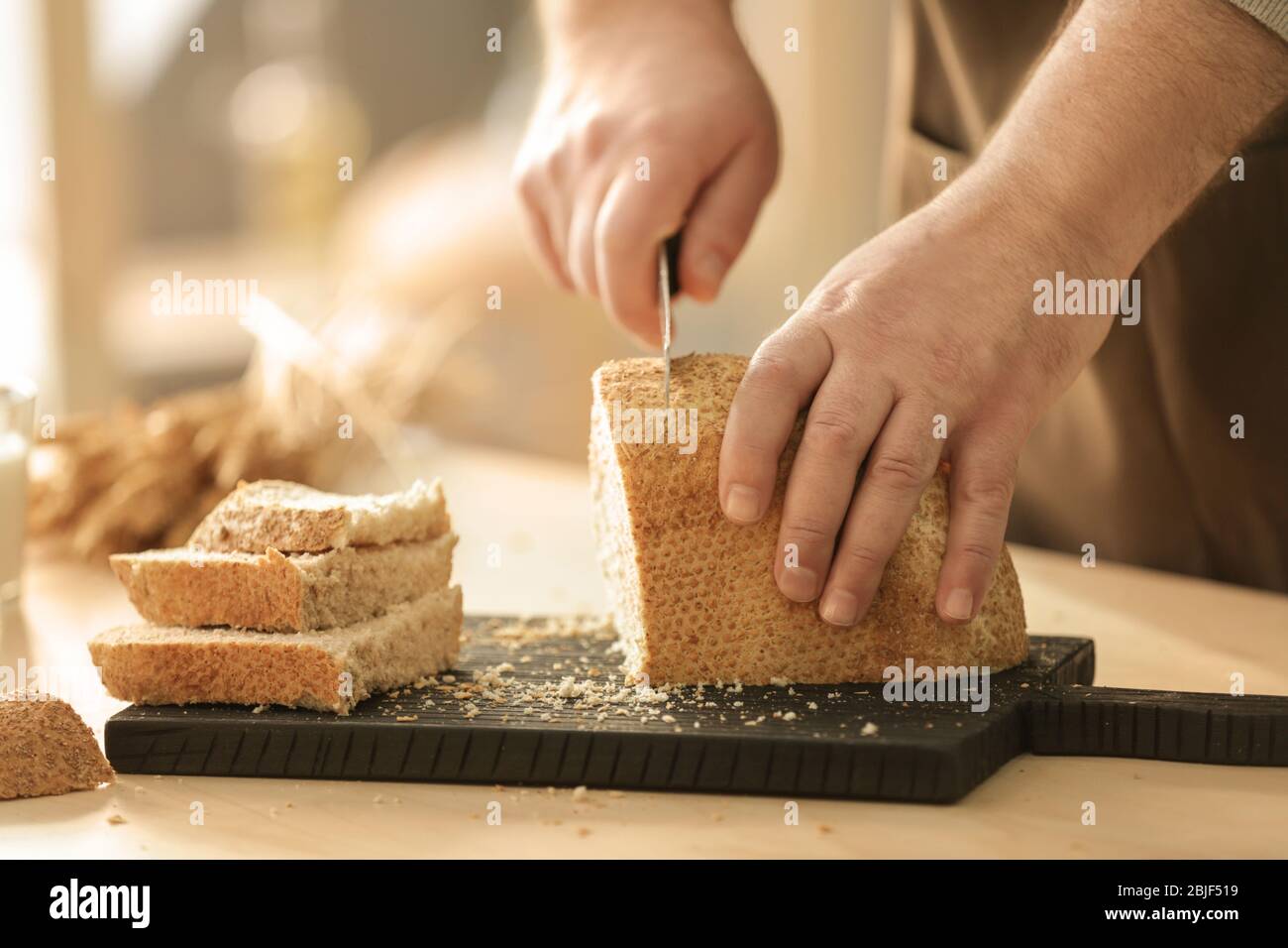 Male hands cutting bread on hi-res stock photography and images - Alamy