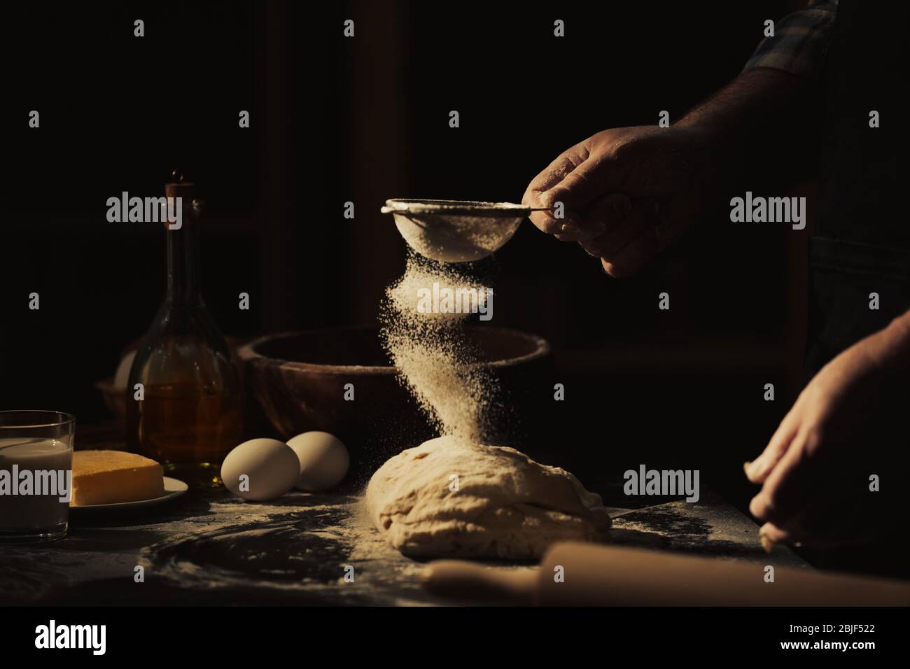 Man making dough in kitchen Stock Photo - Alamy