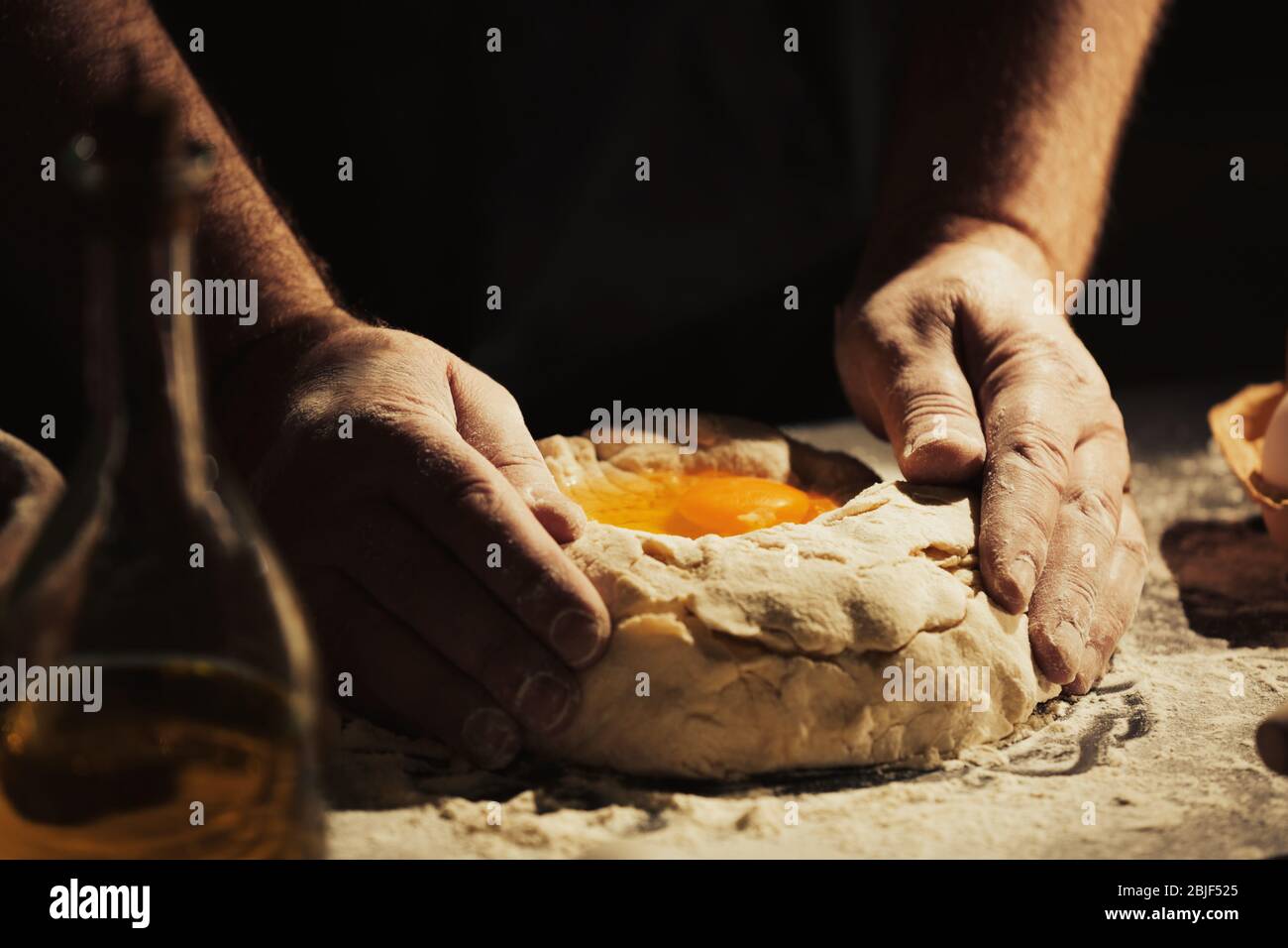 Man making dough in kitchen, closeup Stock Photo - Alamy