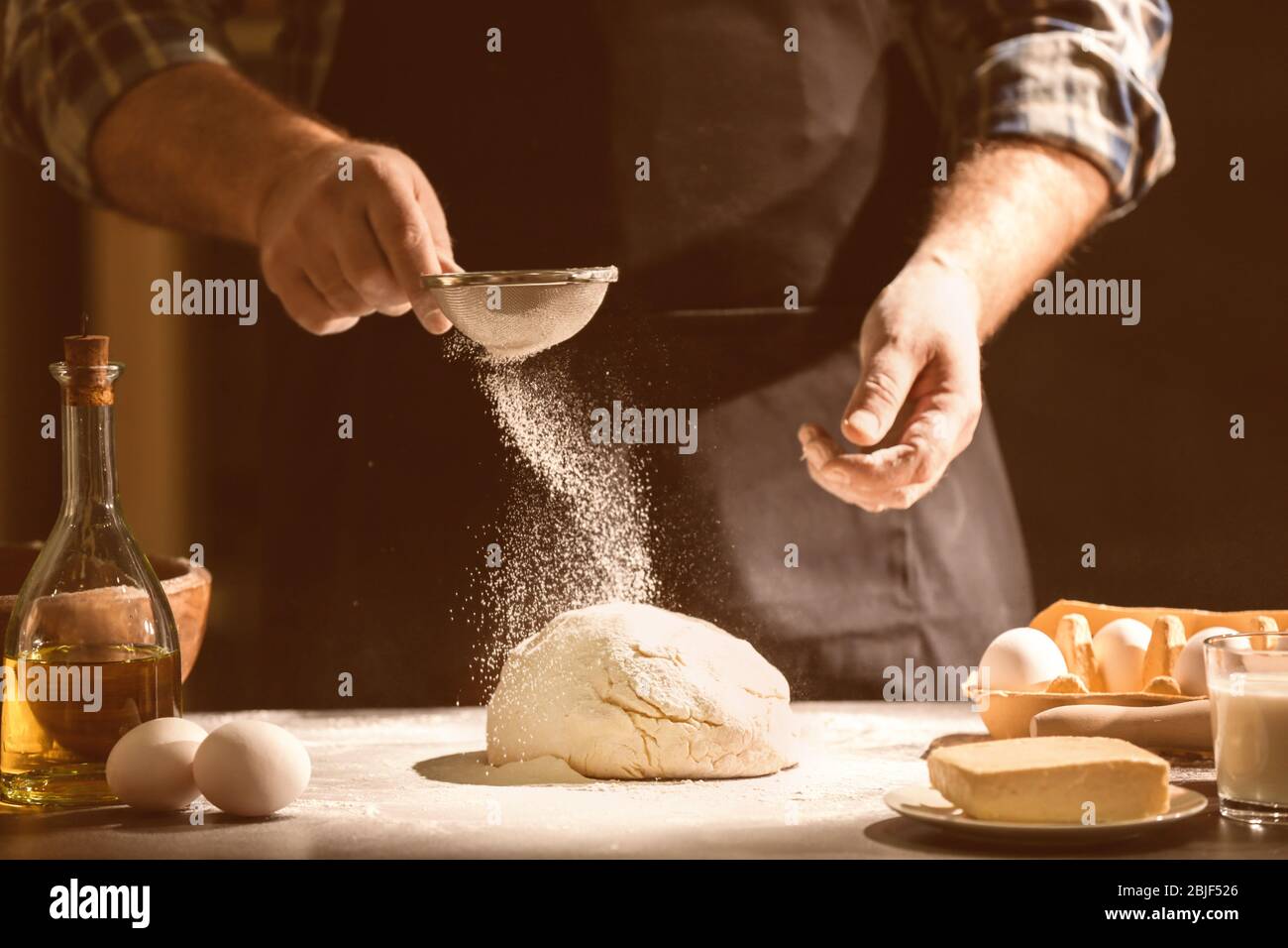 Man making dough in kitchen Stock Photo - Alamy