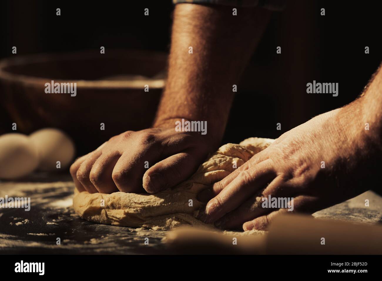 Hands of man kneading dough in kitchen, closeup Stock Photo - Alamy