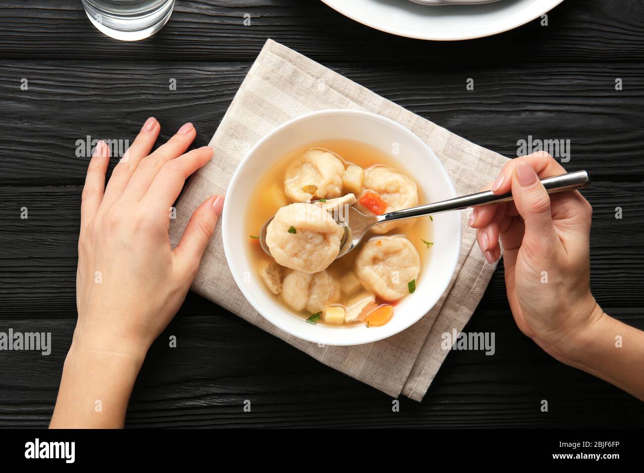 Female hands eating portion of delicious chicken and dumplings on ...