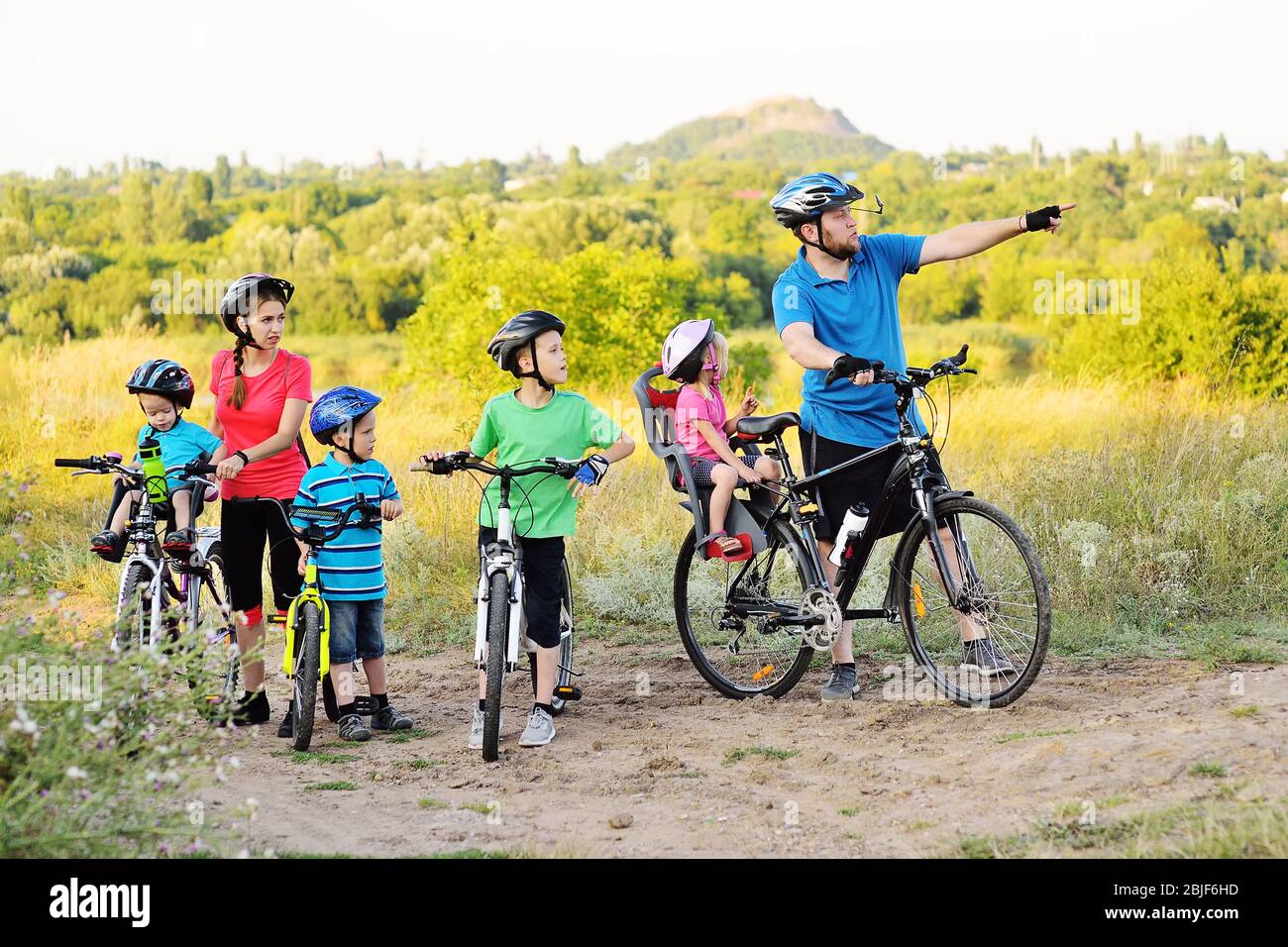 group of people on bicycles - two adults and four young children in ...