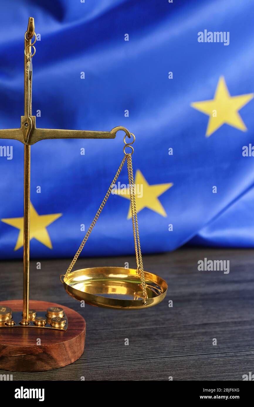 Scales on European Union flag background Stock Photo - Alamy