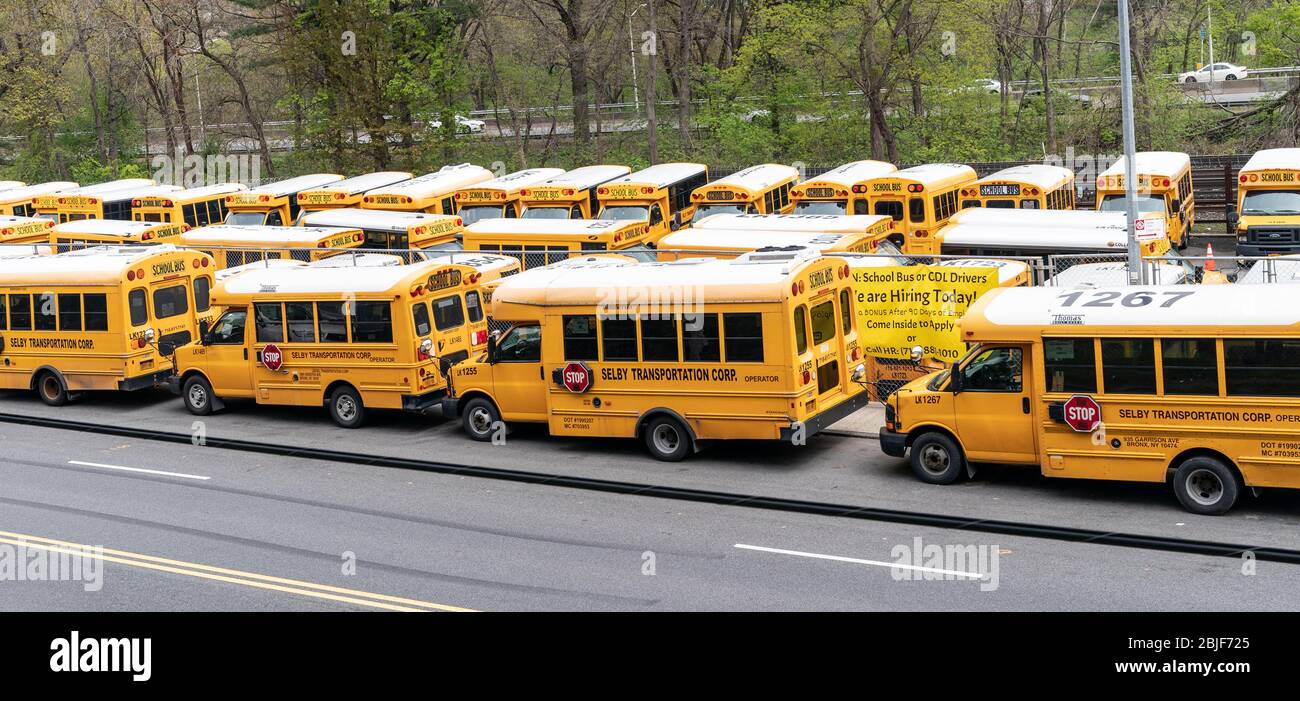 New York, NY - April 29, 2020: School buses stand idle on the parking ...
