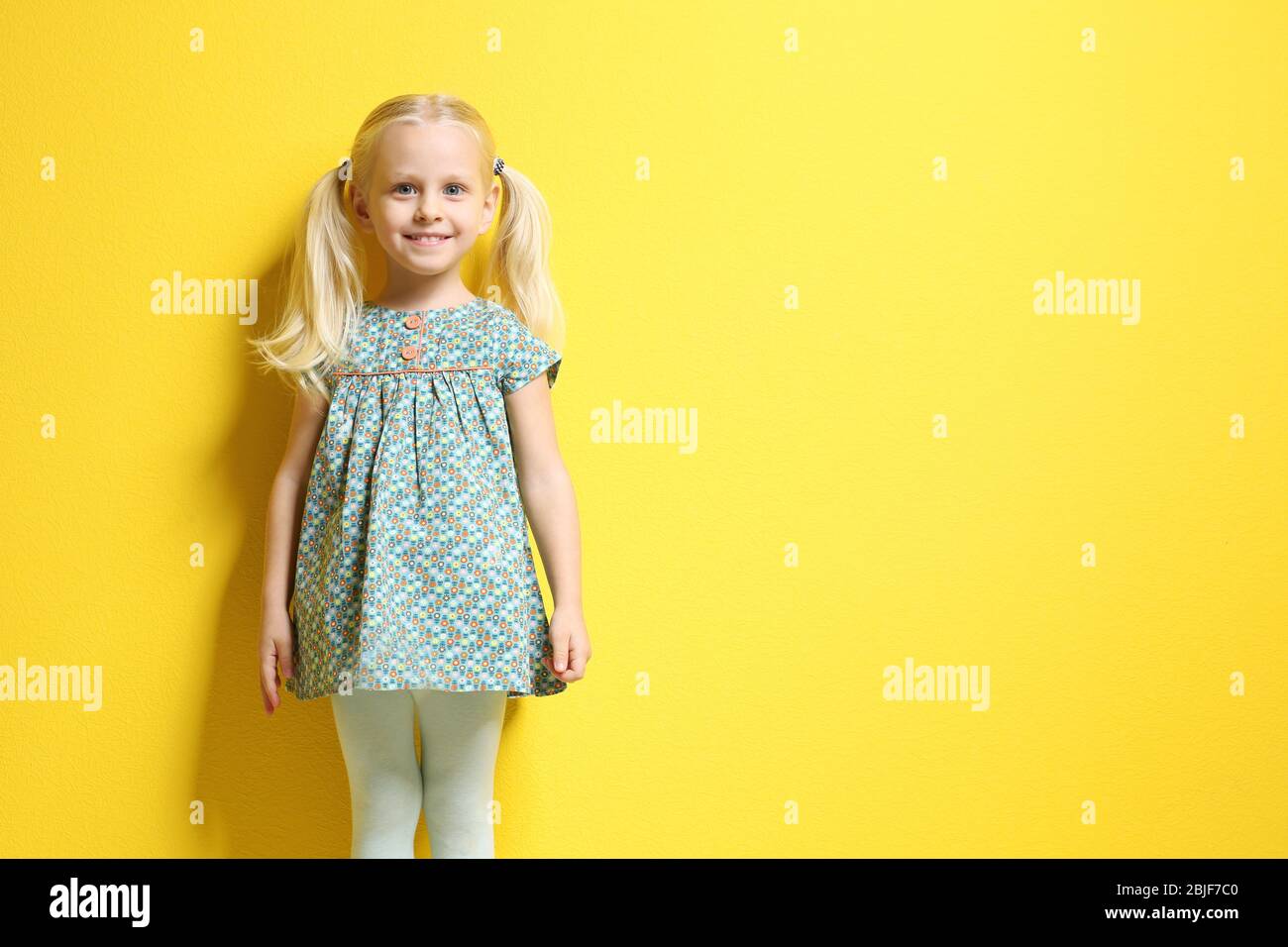 Cute little girl on color background Stock Photo - Alamy