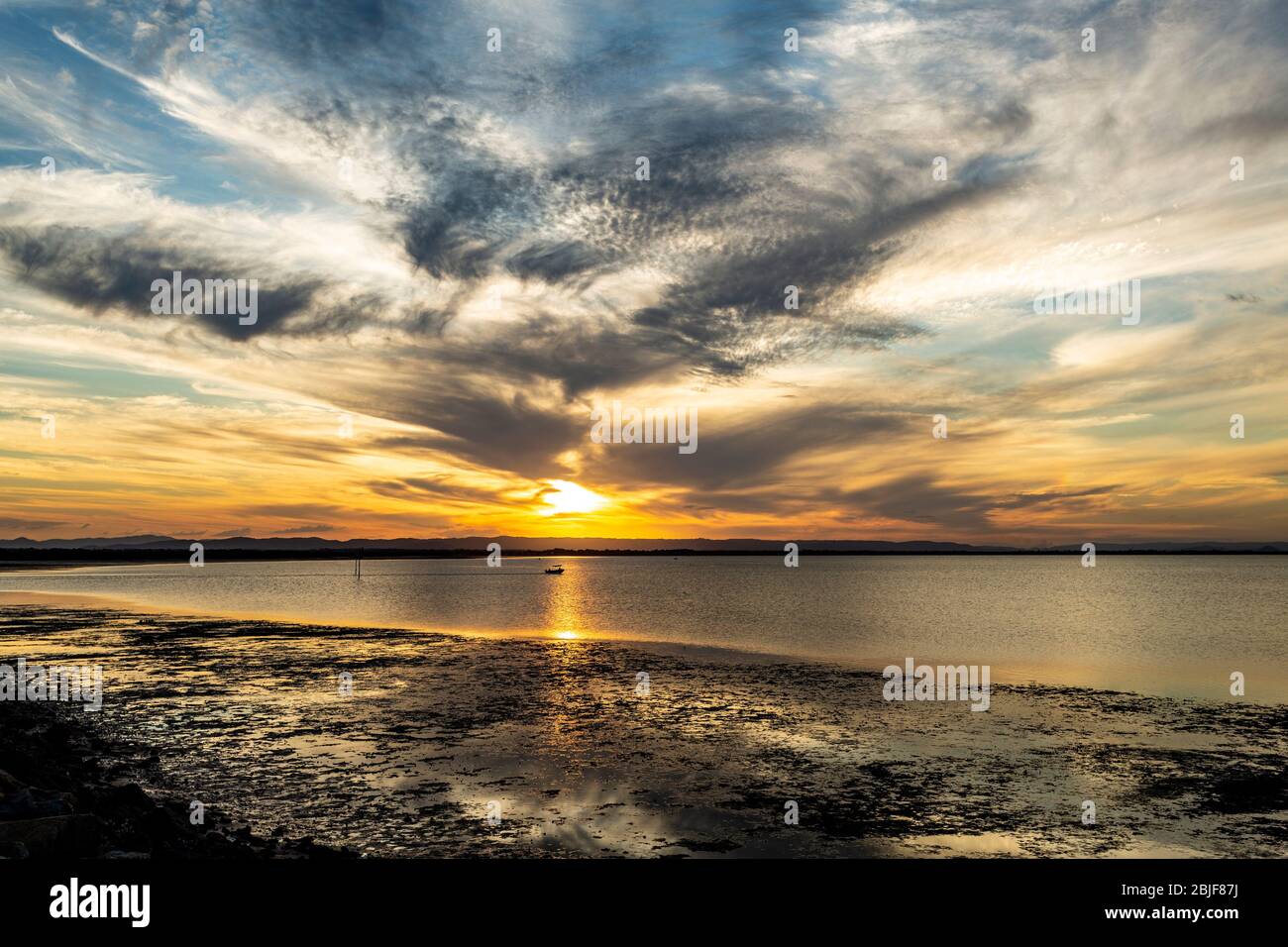 Stunning colours of a sunset behind the town of Deception Bay ...