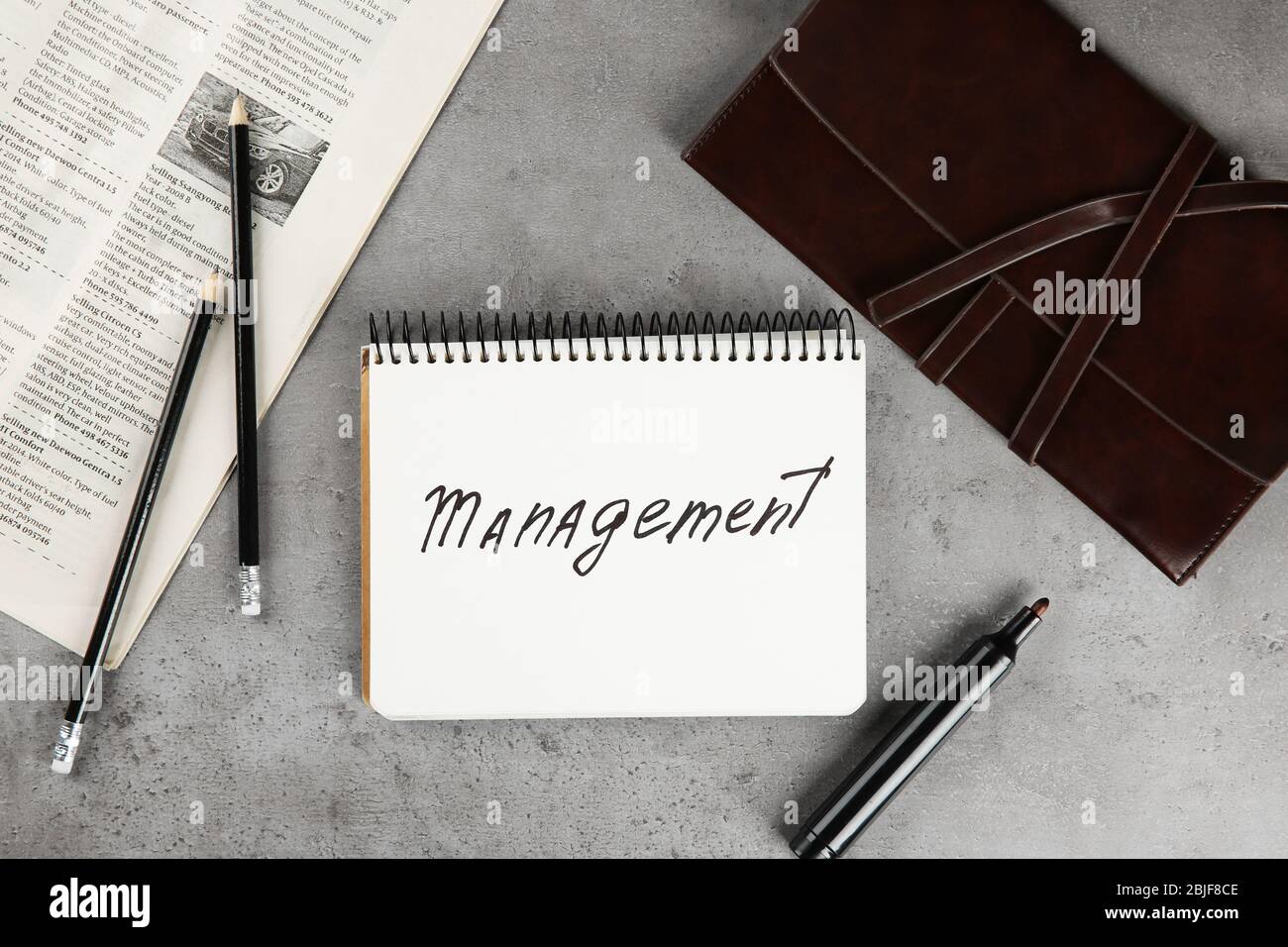 Notebook with written word MANAGEMENT on texture background Stock Photo ...