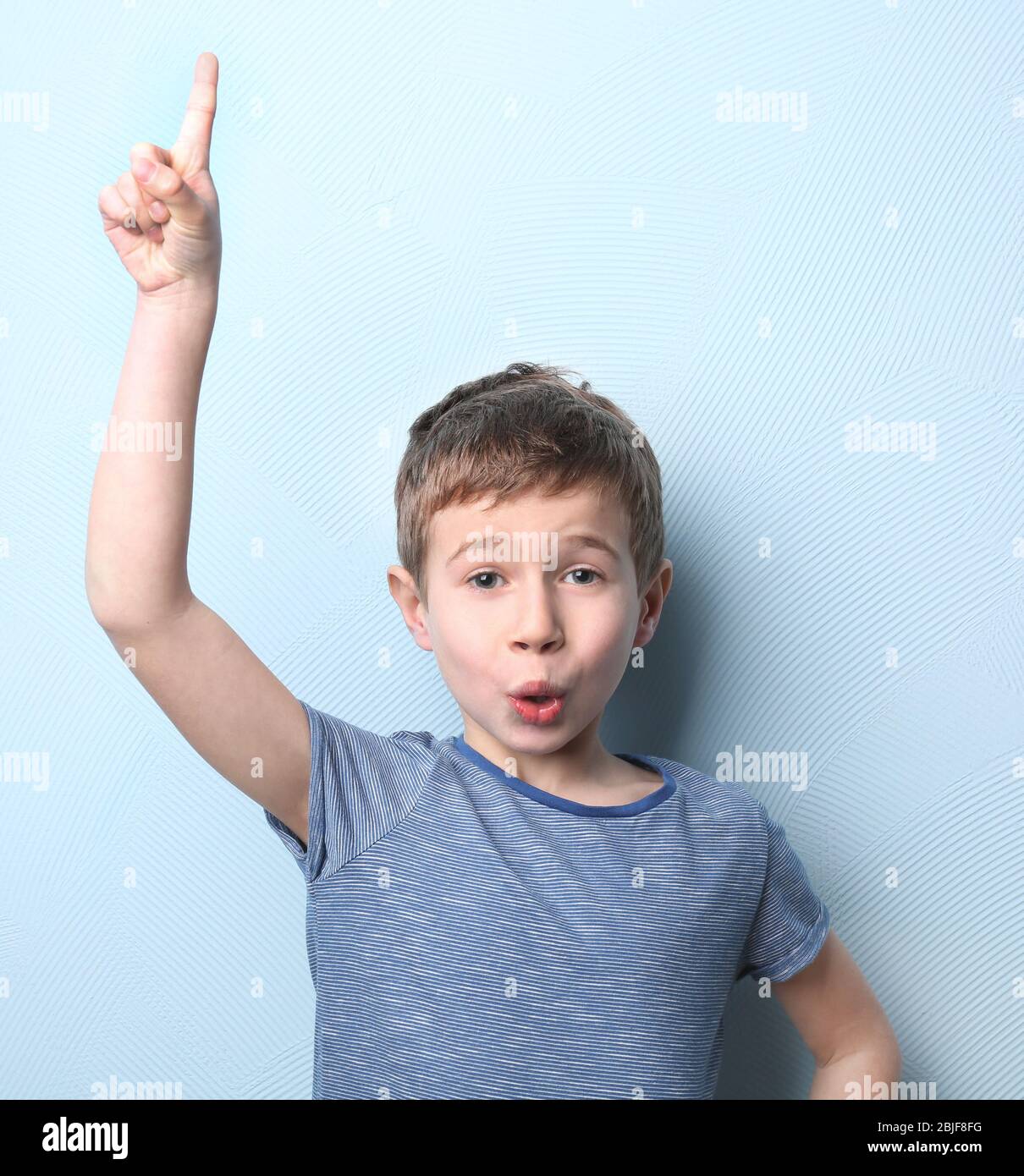 Portrait of little boy on light blue background Stock Photo - Alamy
