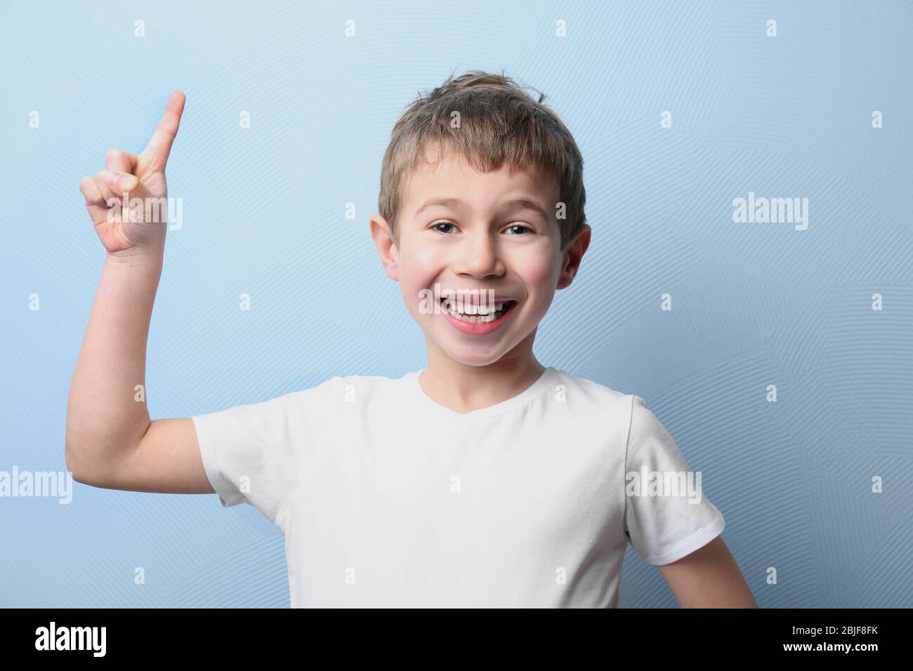 Portrait of little boy on light blue background Stock Photo - Alamy