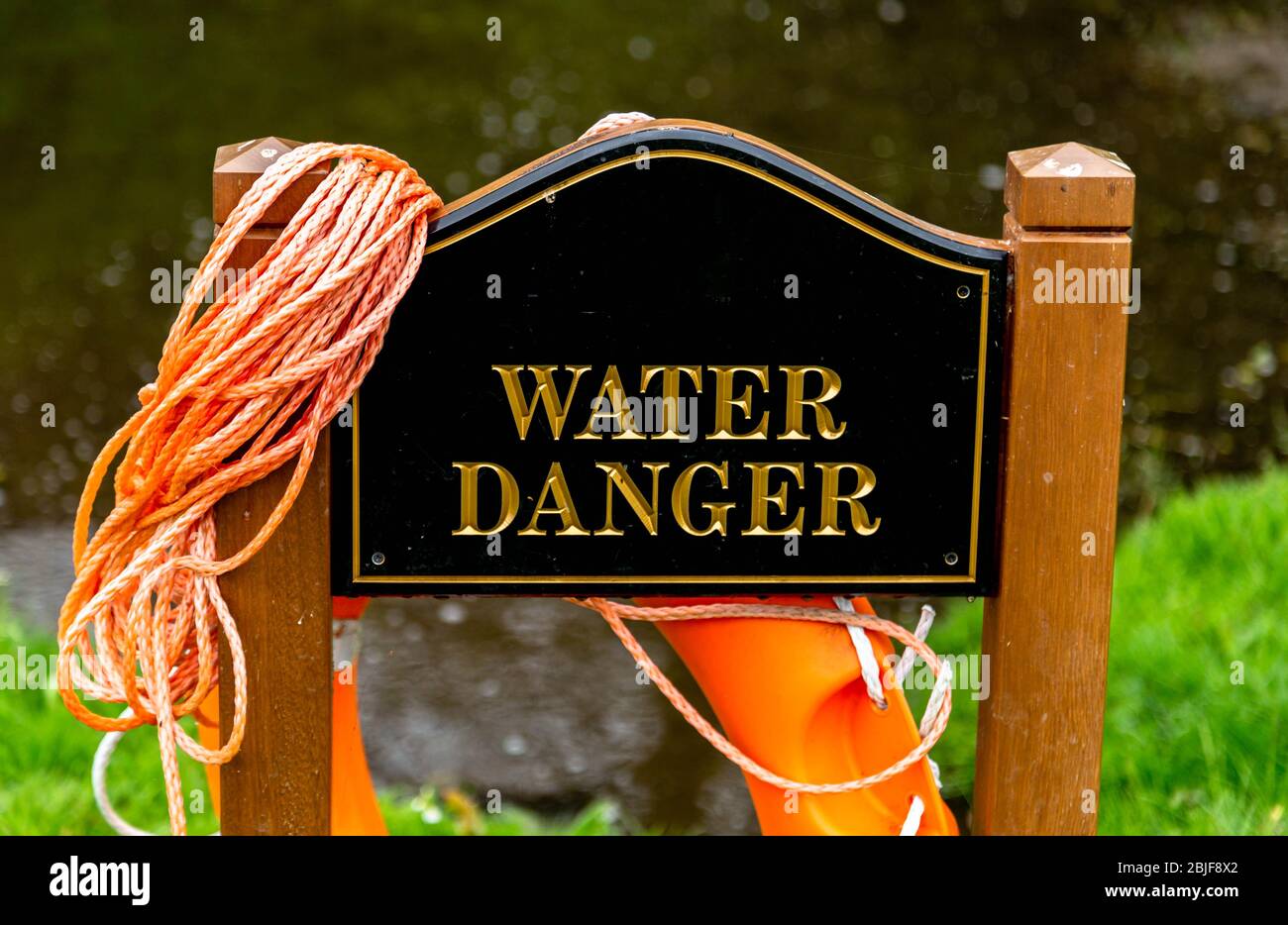 A water danger warning sign together with a rope and lifebuoy Stock ...